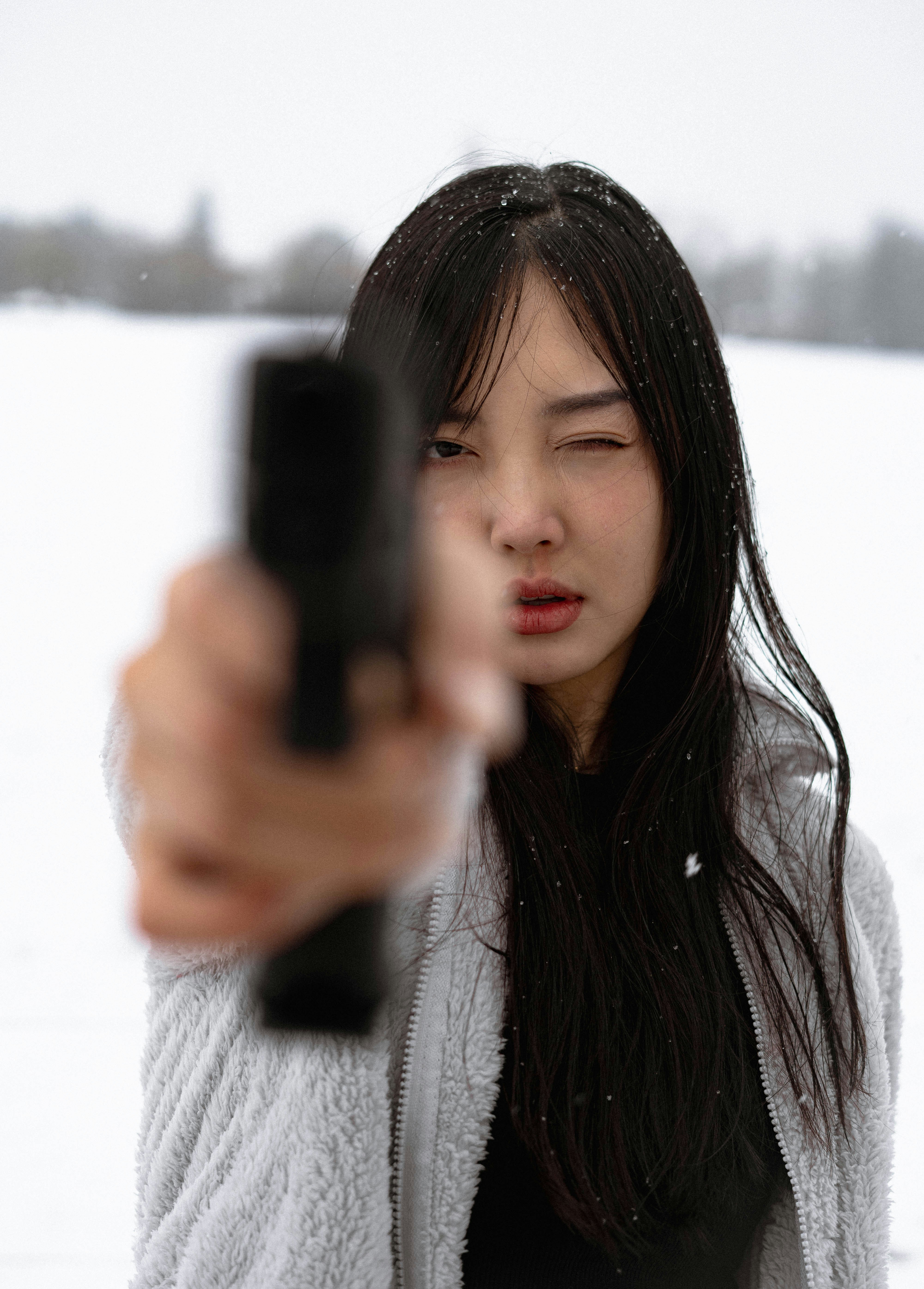A woman holding a gun in the snow photo – Free Photography Image on ...