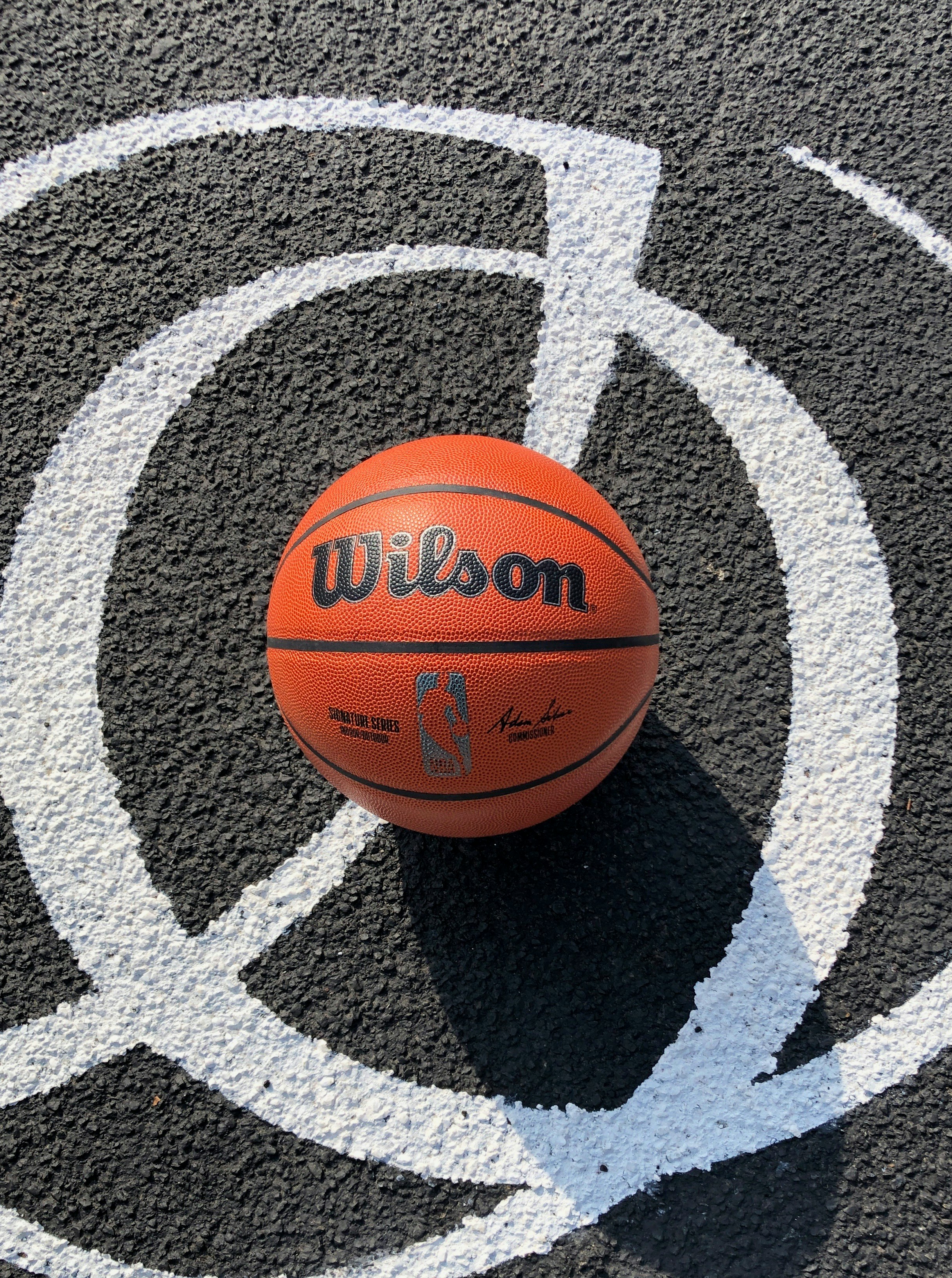 Centered Orange Basketball Nestled Within White Court Circles