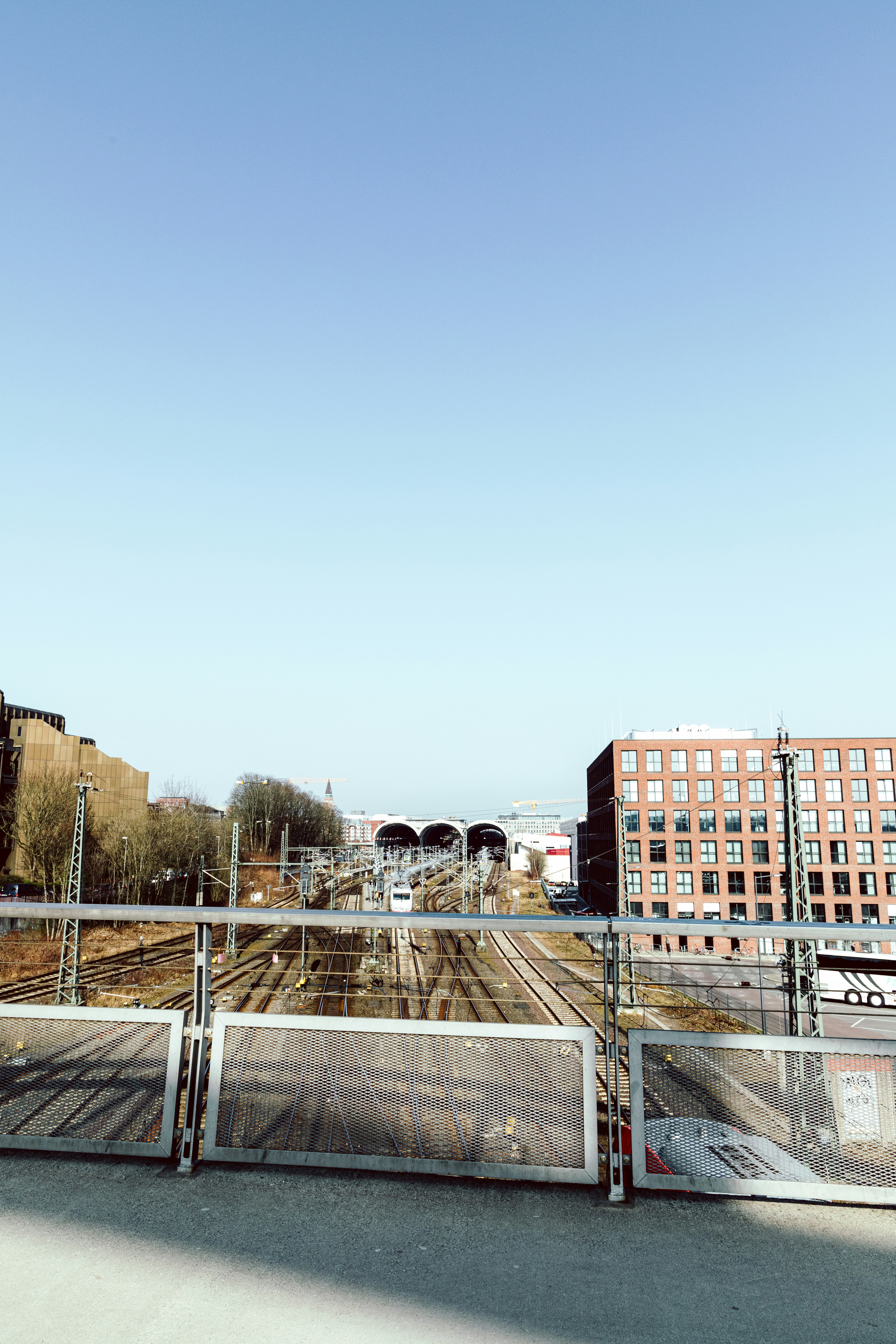 A view of a train track through a fence photo – Free Building Image on ...