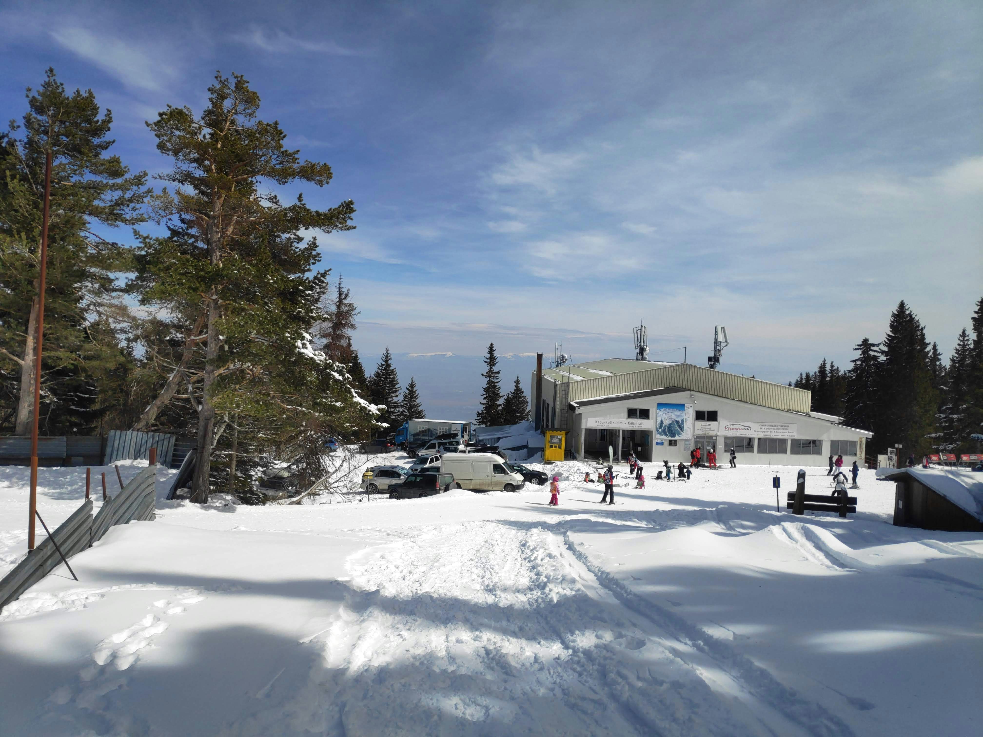 A group of people standing outside of a building in the snow photo ...