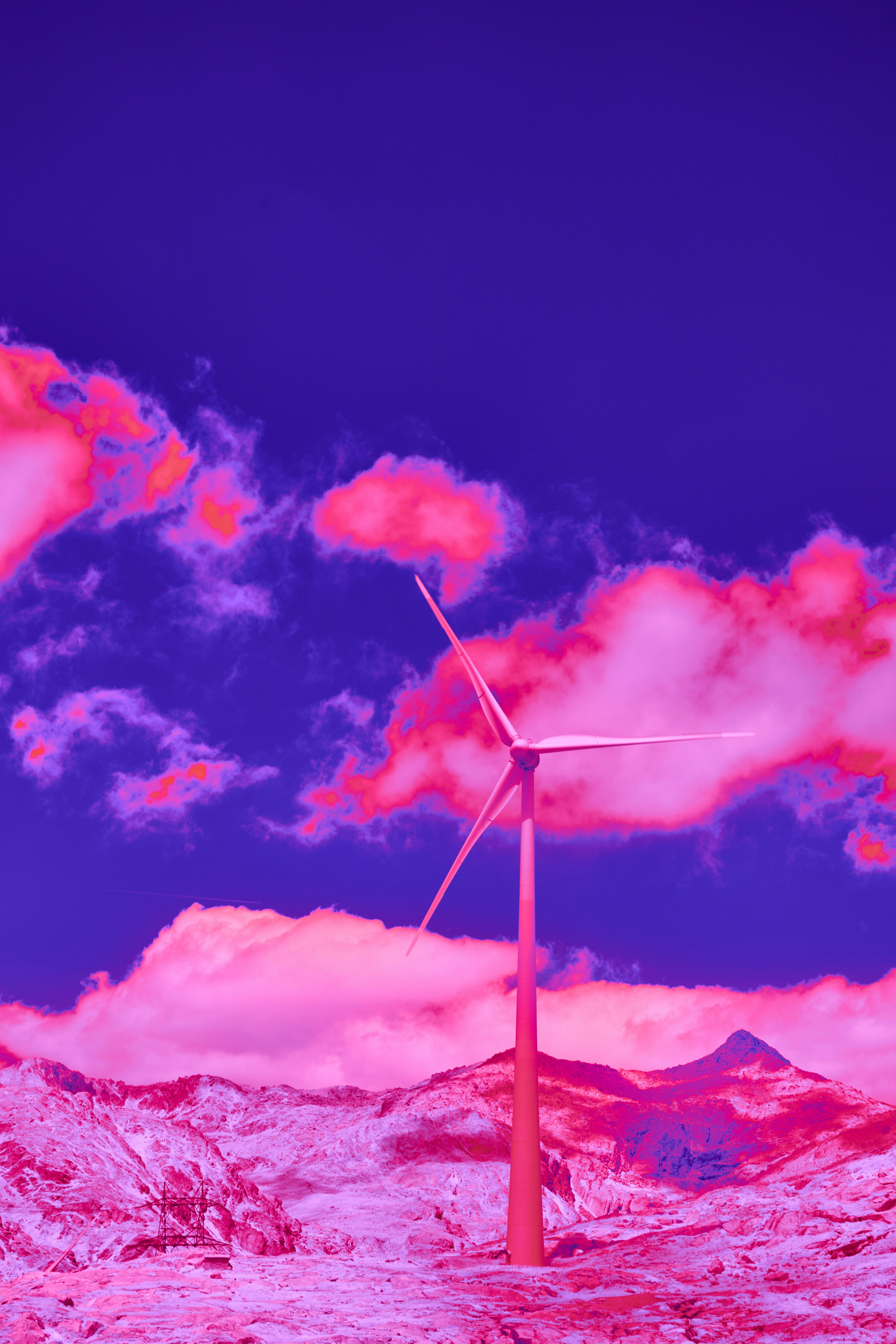 Neon Turbine Over a Pink-Hued Alpine Ridge
