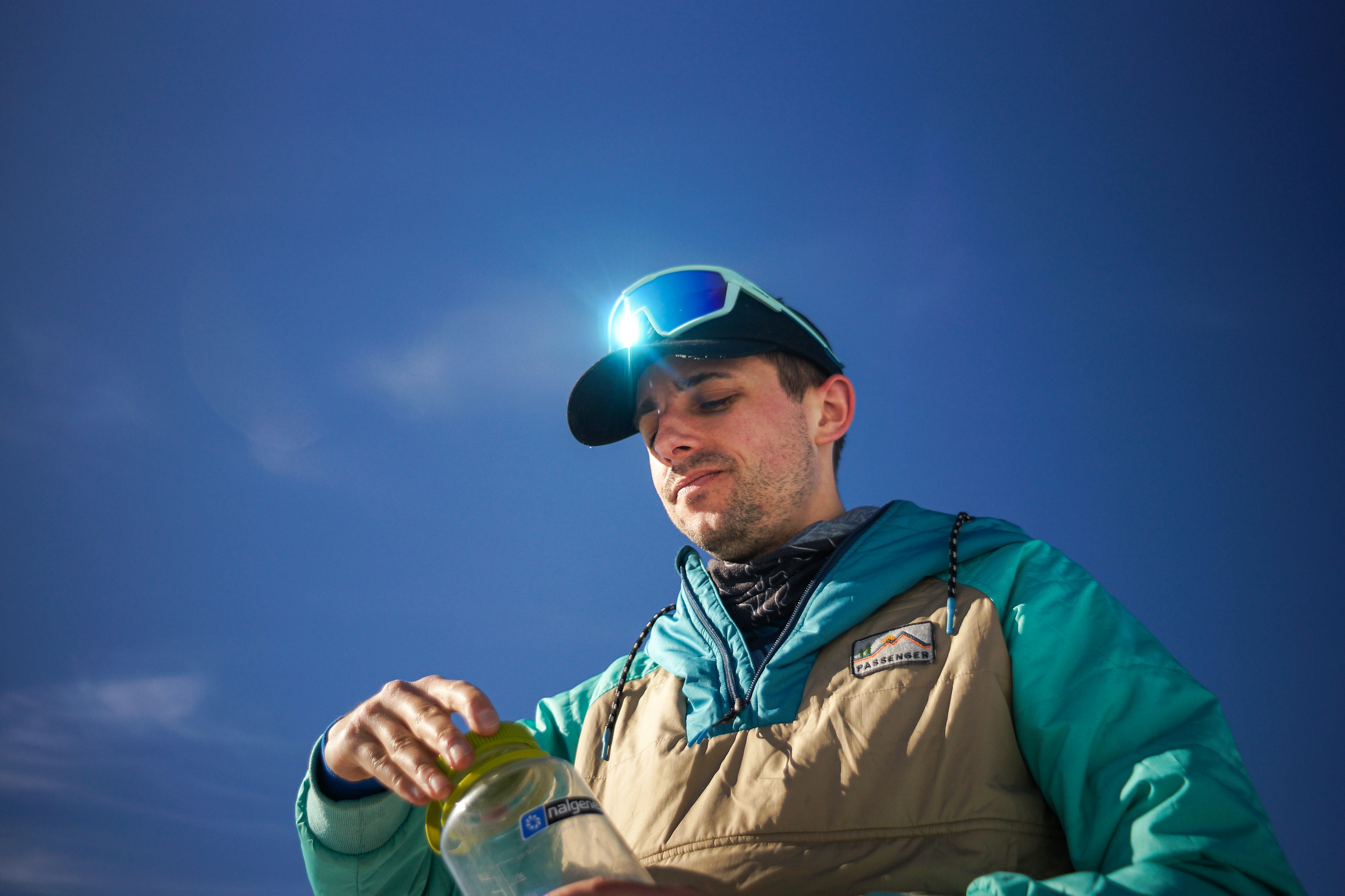 Sunlit Gaze: An Outdoor Portrait in Teal and Beige