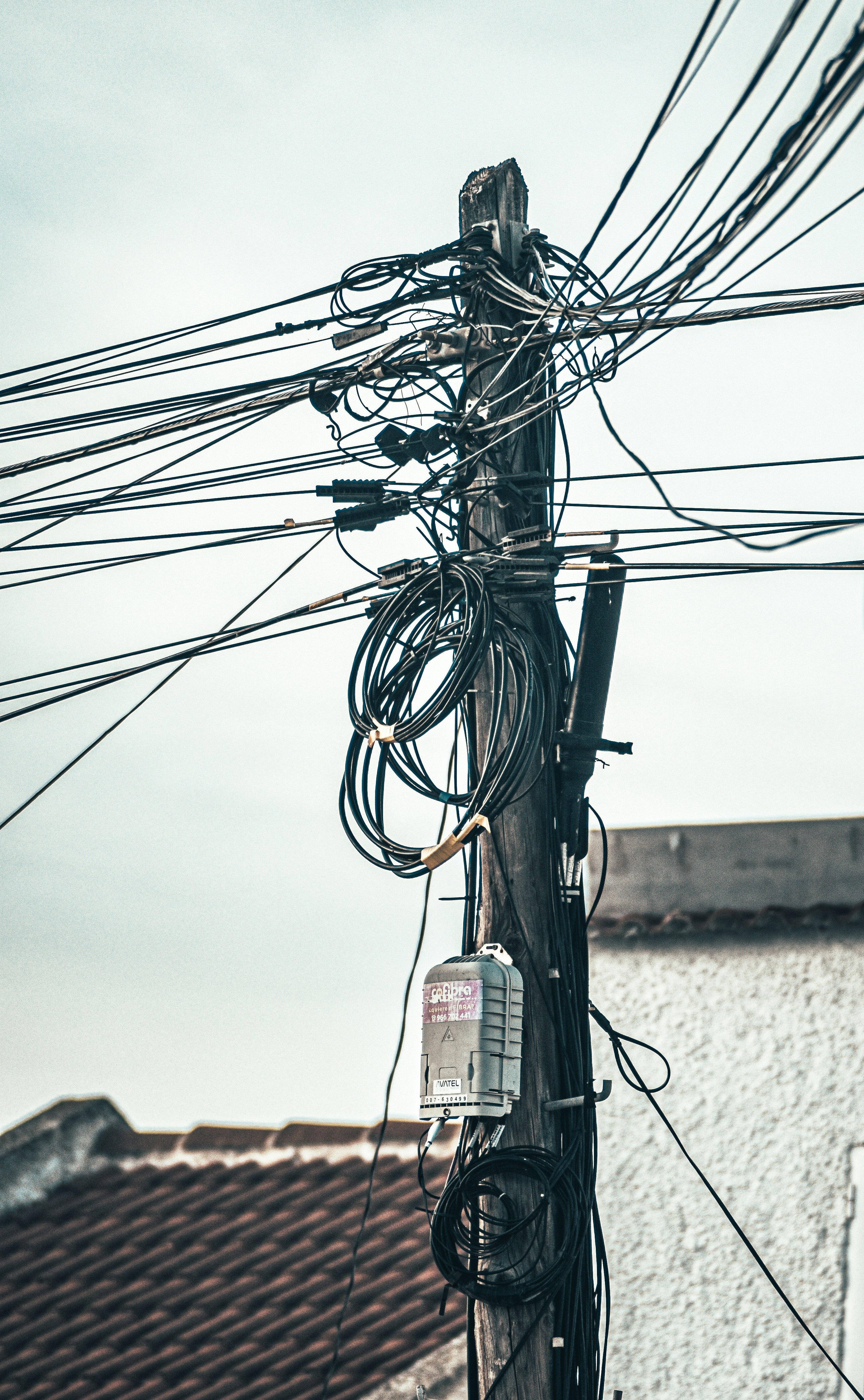 A bunch of wires and wires hanging from a pole photo – Free Spain Image ...