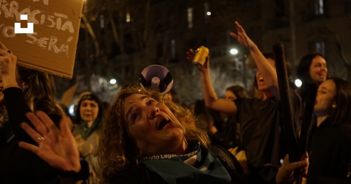 Foto Un grupo de personas sosteniendo carteles por la noche – Imagen ... Foto Un grupo de personas sosteniendo carteles por la noche – Imagen ...