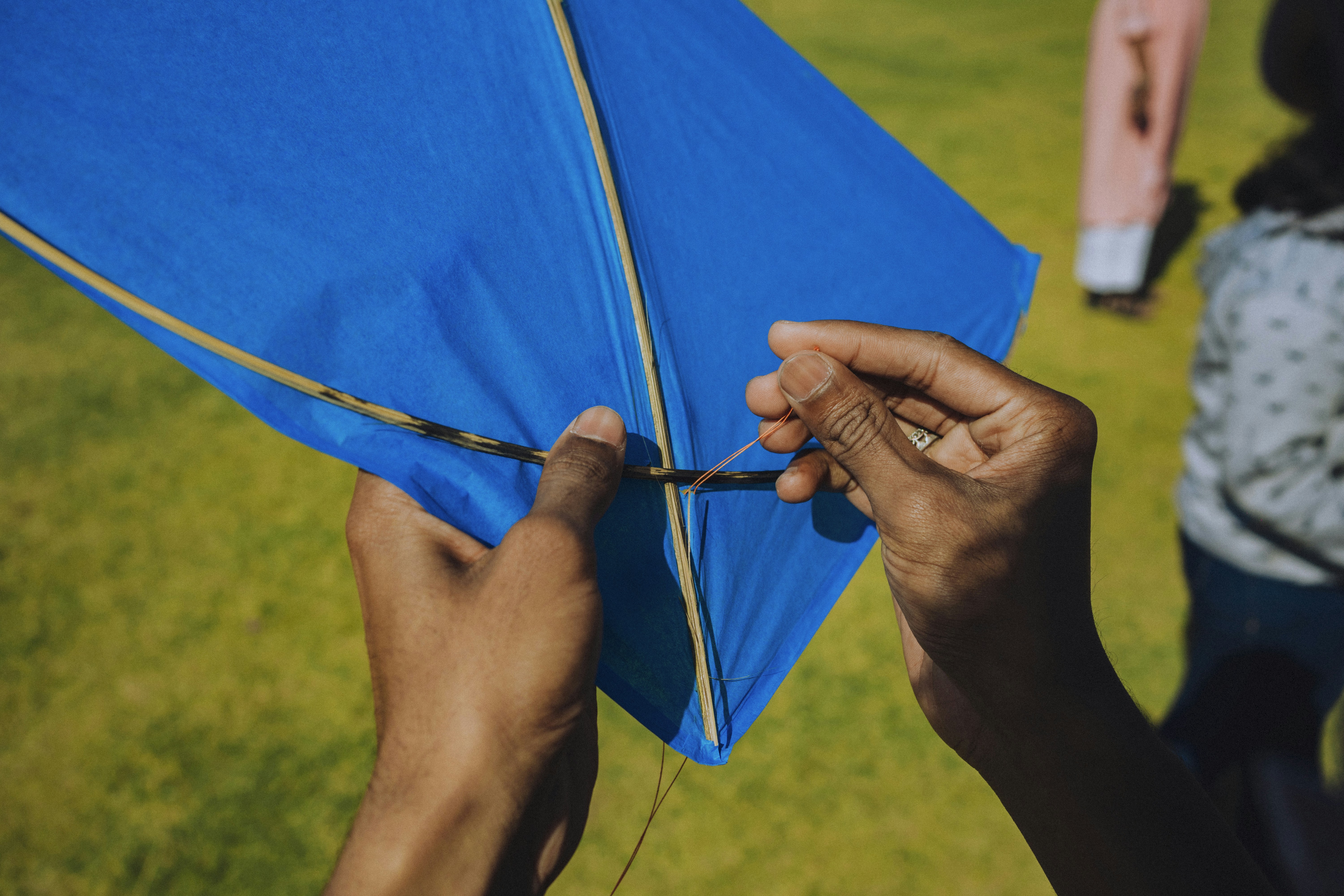 a person holding a blue umbrella in their hands