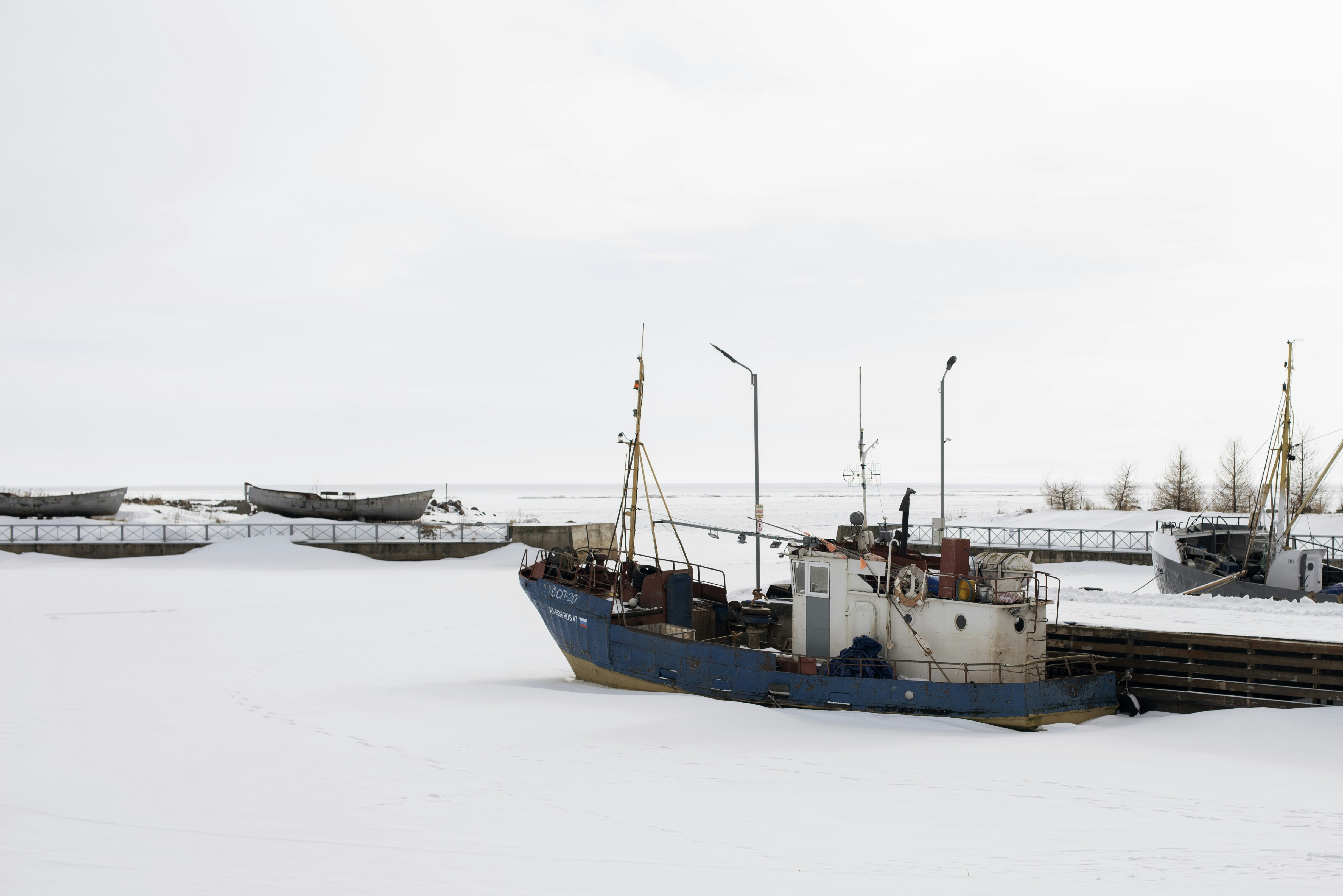 A boat sitting on top of snow covered ground photo – Free Ladozhskoe ...