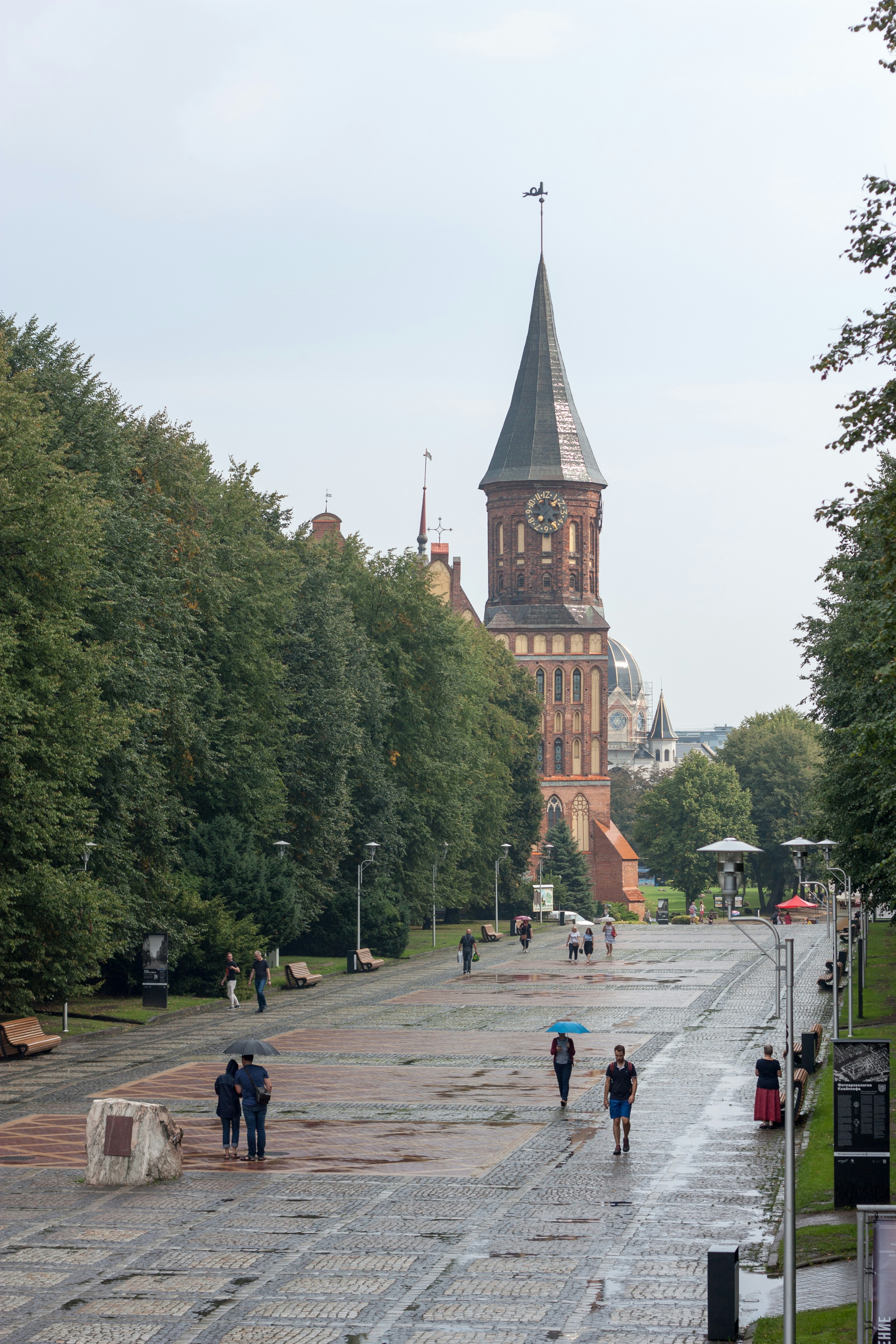 Brick Clock Tower on a Rain-Washed Promenade