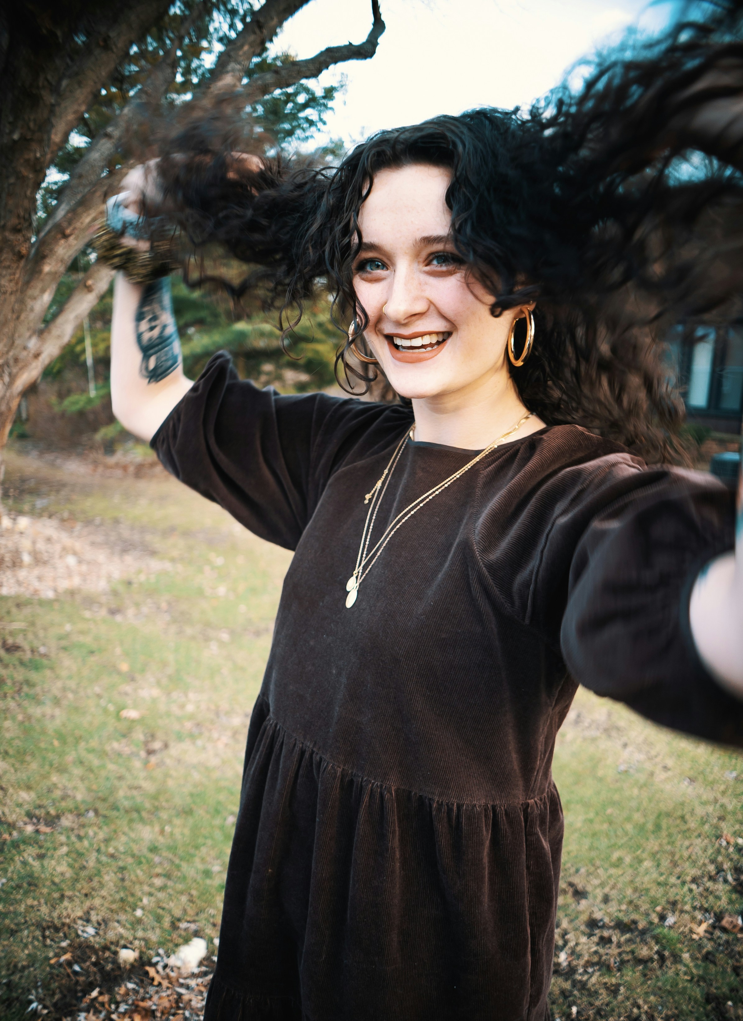 Spiraling Hair and a Beaming Smile: A Breezy Portrait in the Park