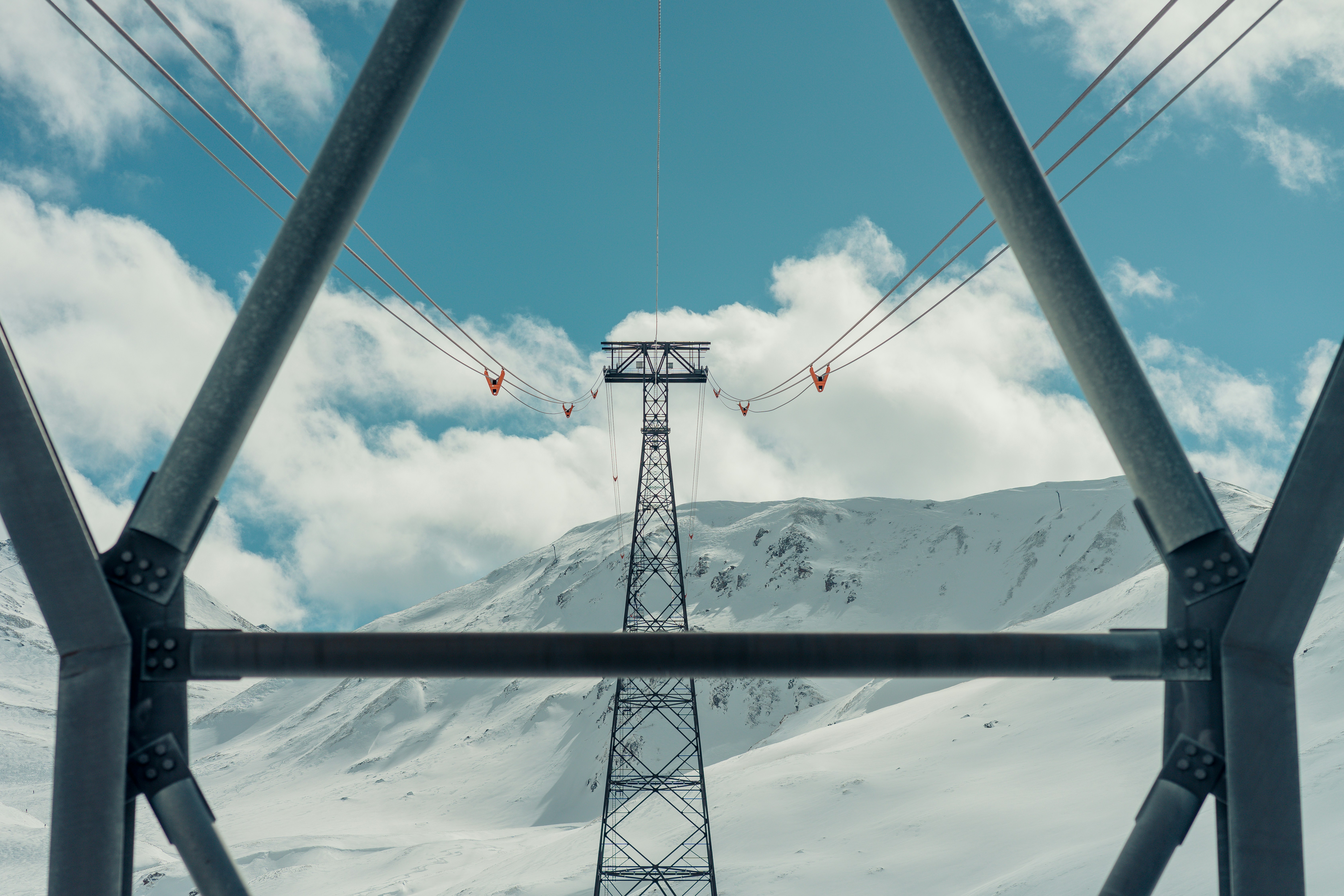 a ski lift going up a snowy mountain