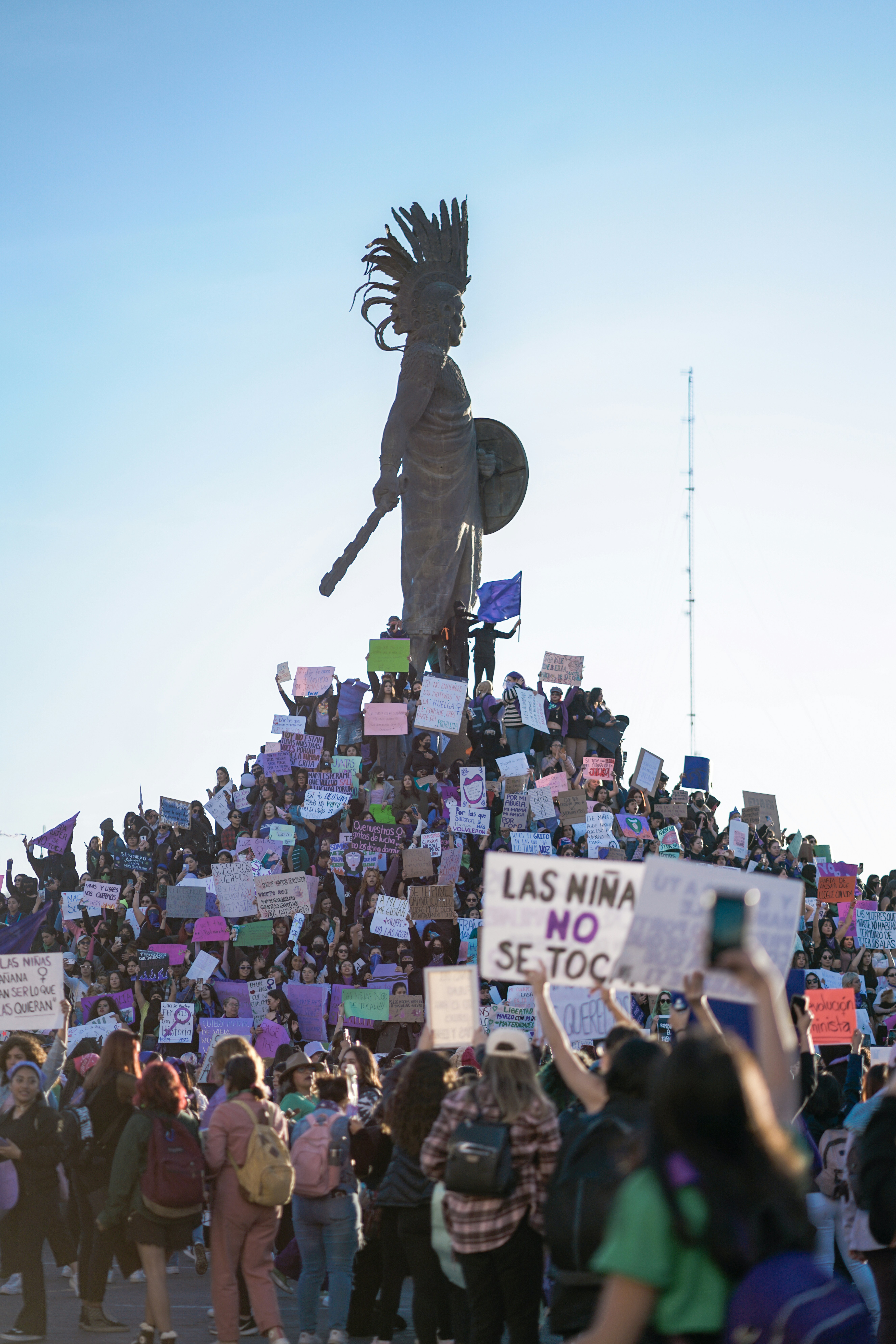 Crowd Uprising at the Monument: Voices Raised Around a Warrior Statue