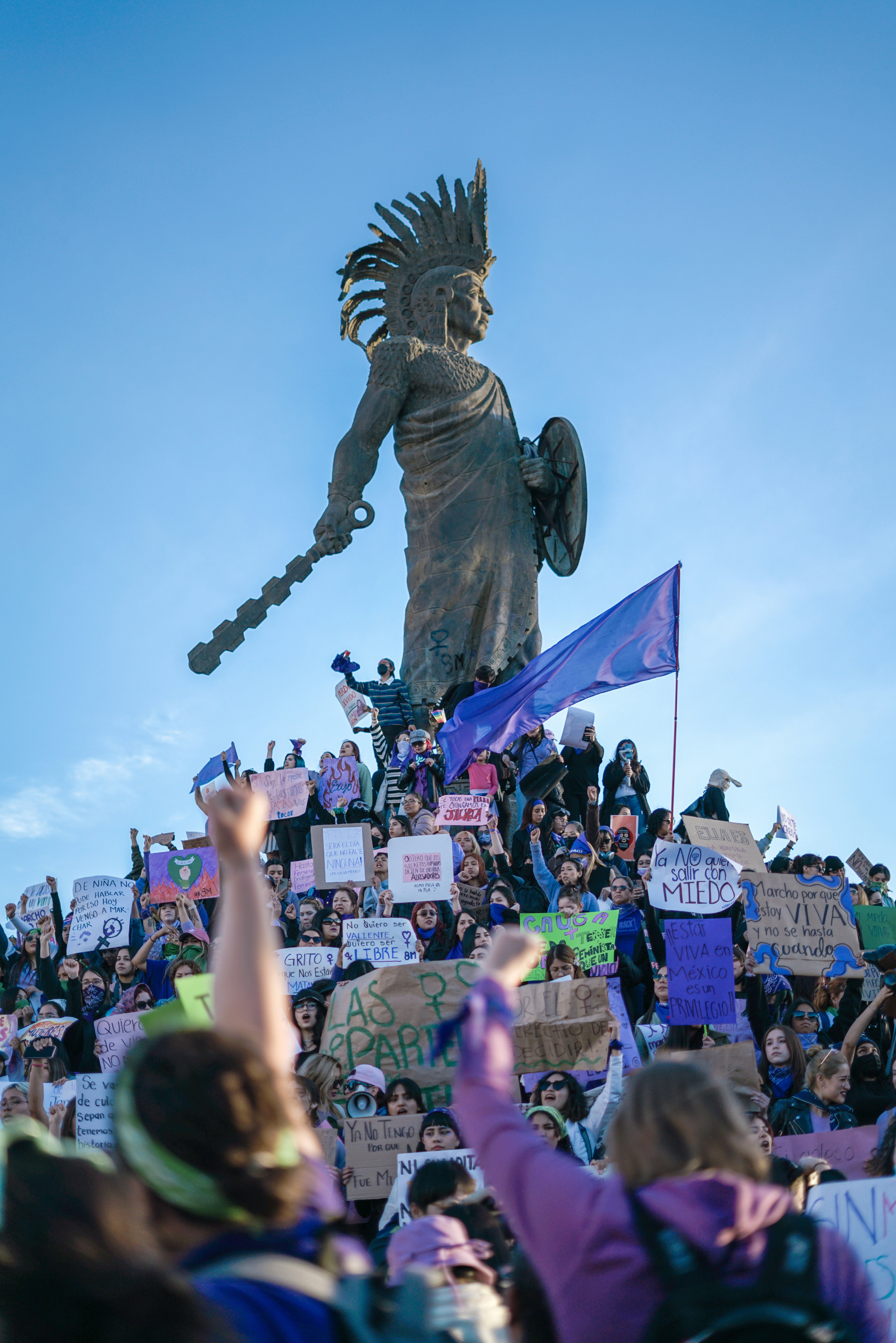 A crowd of people standing around a statue photo – Free Parade Image on ...