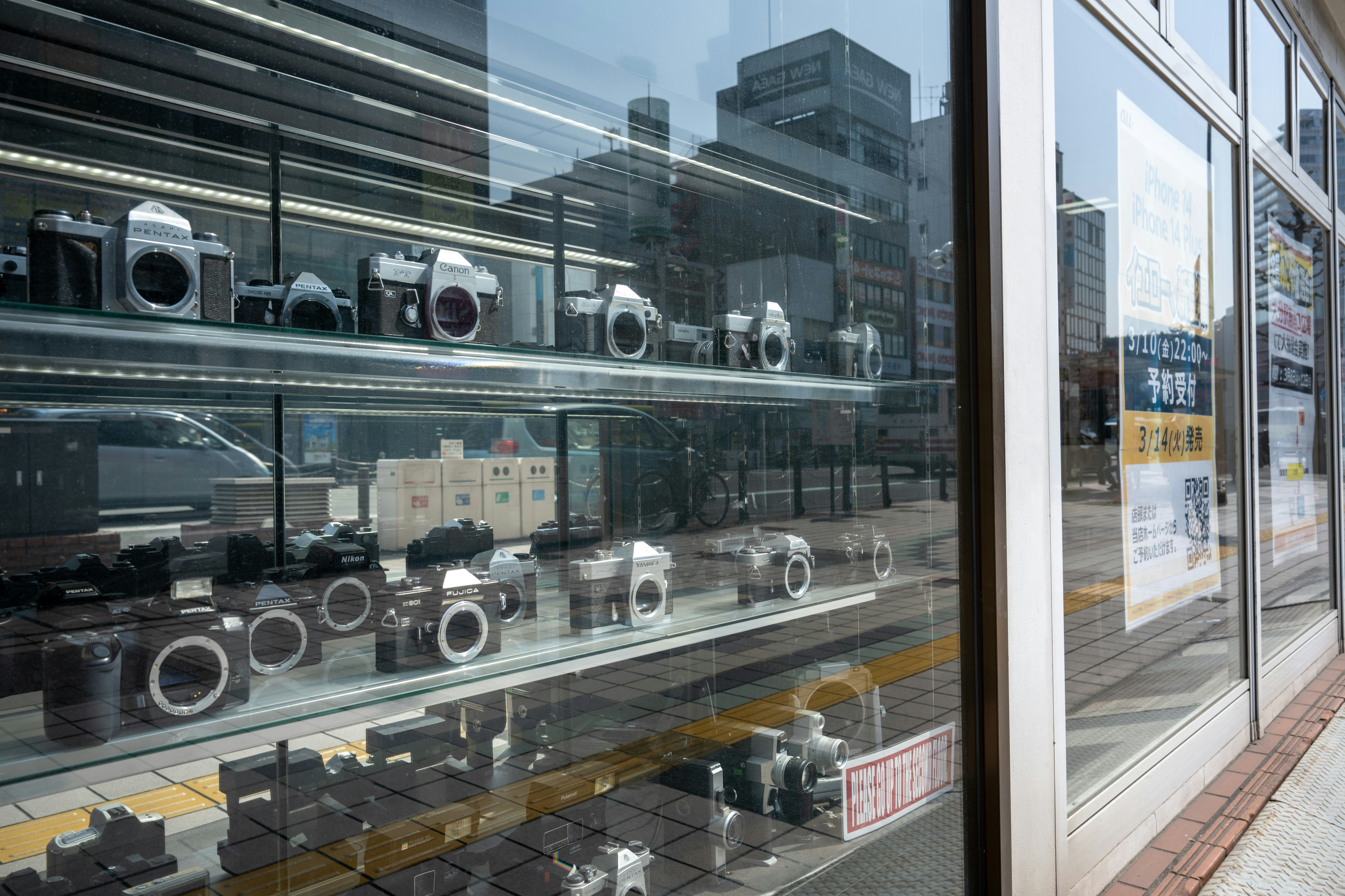 A store front with a lot of cameras in the window photo – Free Building ...