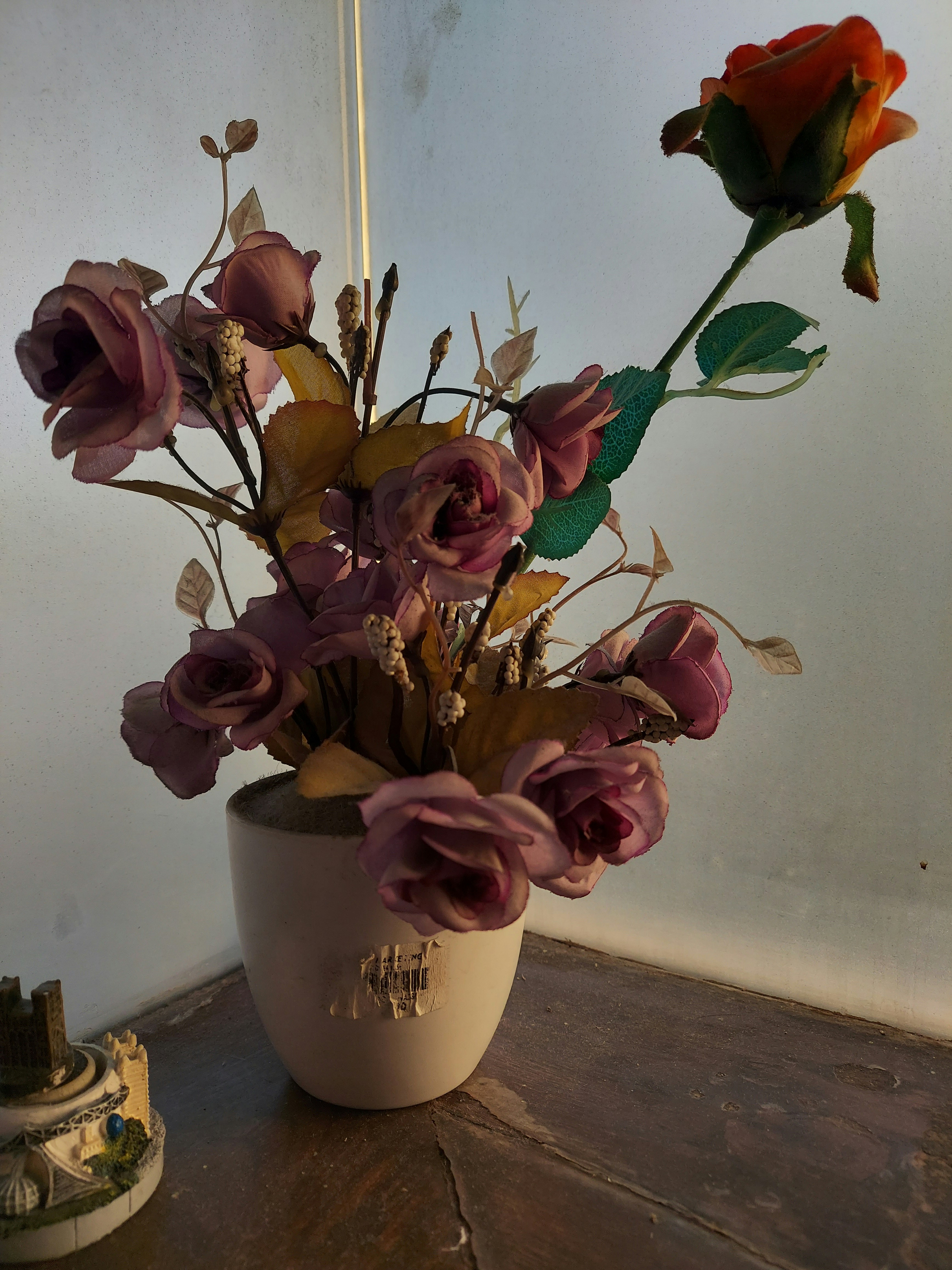 a vase filled with flowers on top of a wooden table