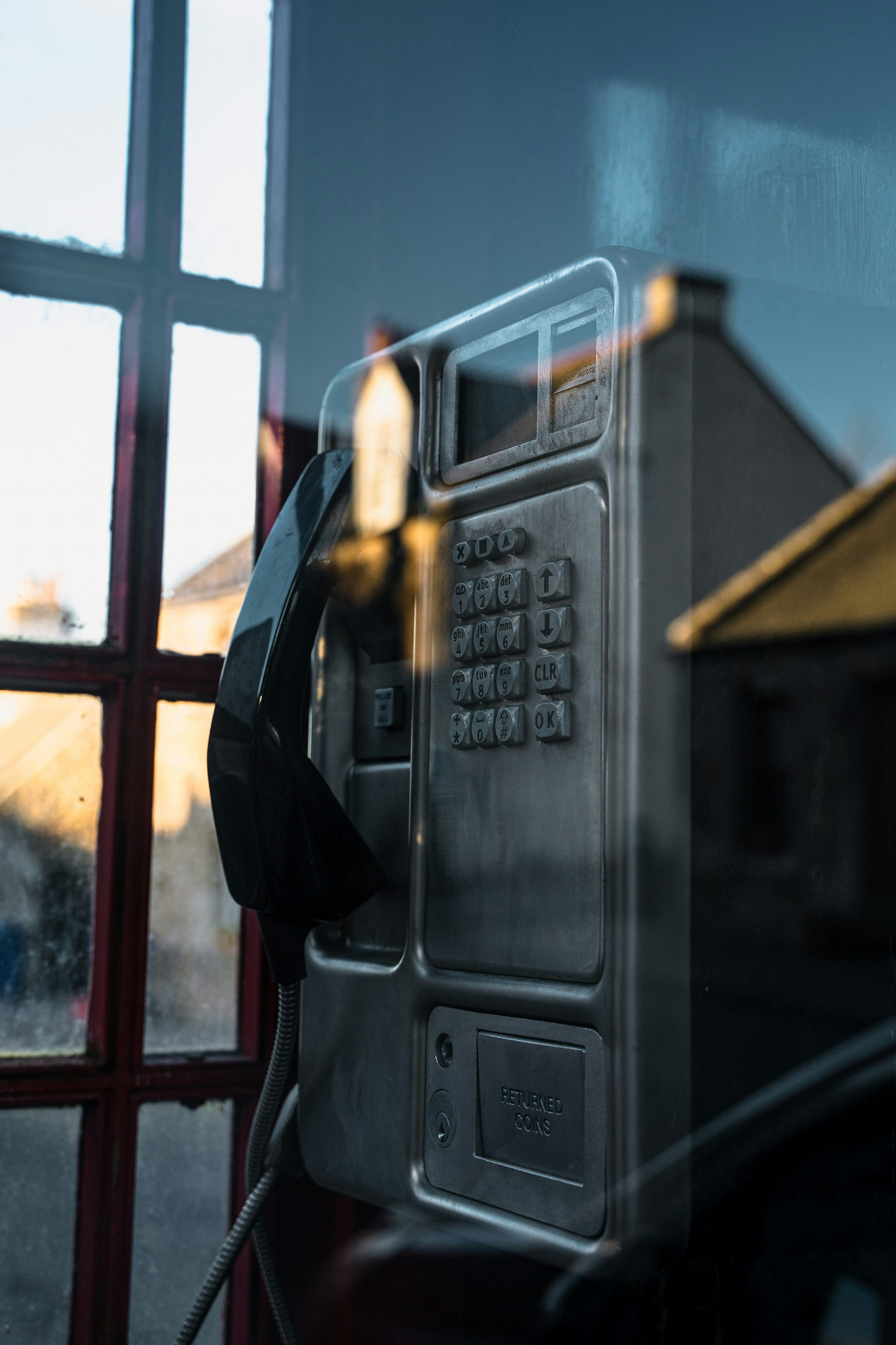 An old fashioned telephone is reflected in a window photo – Free United ...
