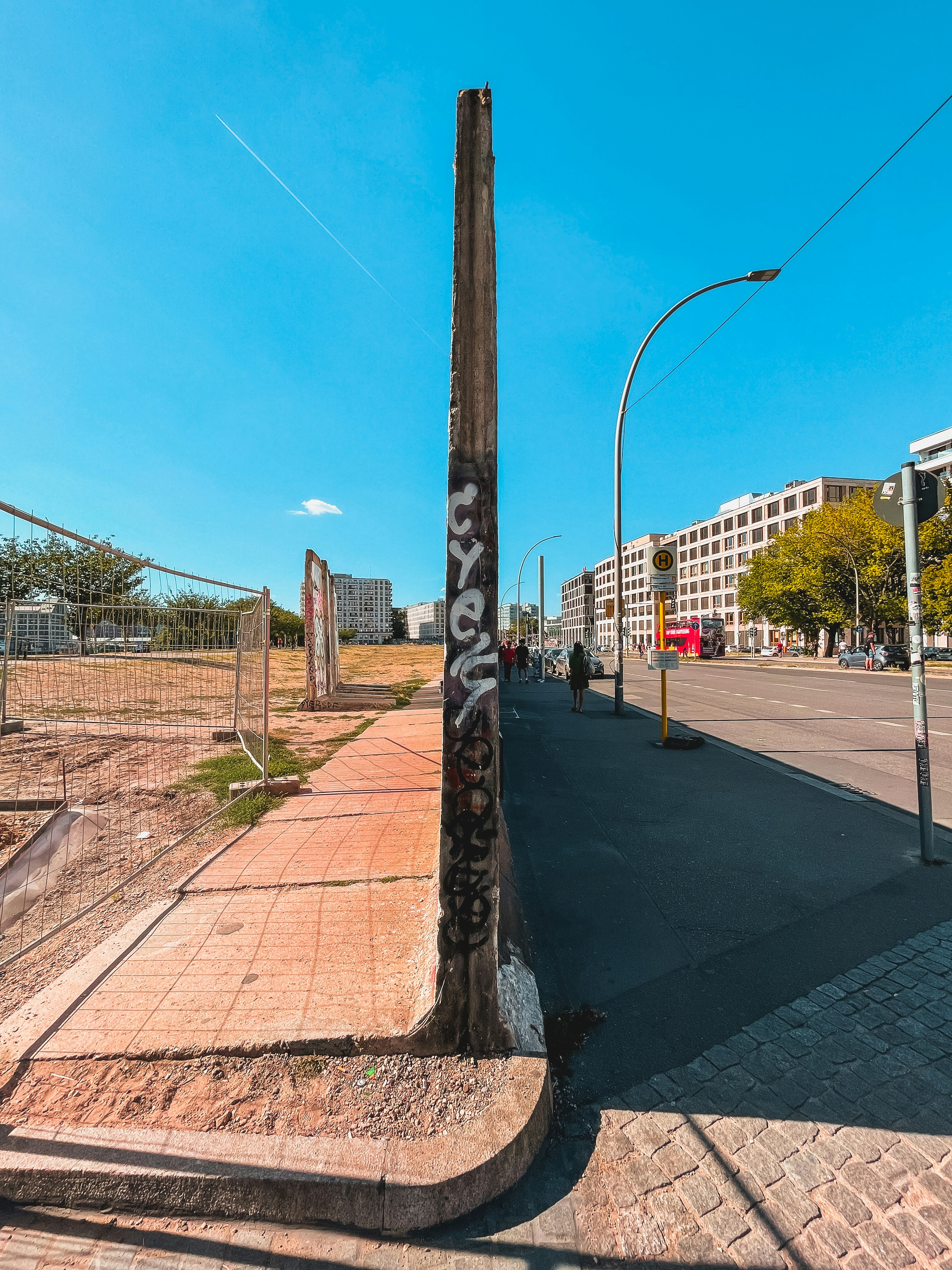 A pole with graffiti on it on the side of a road photo – Free Berlin ...