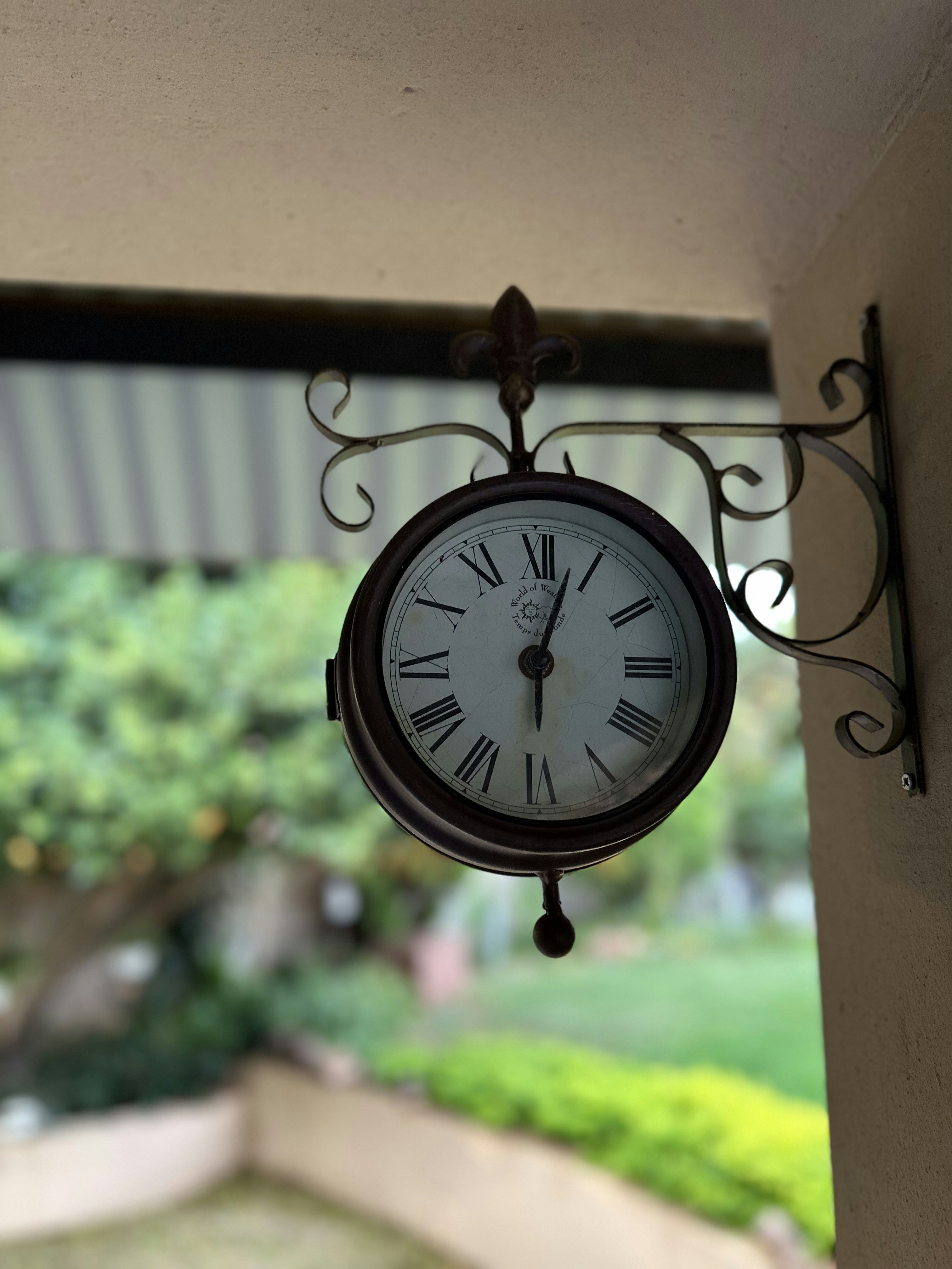 Timeless Toll: A Clock Hung in Quiet Outdoor Oasis