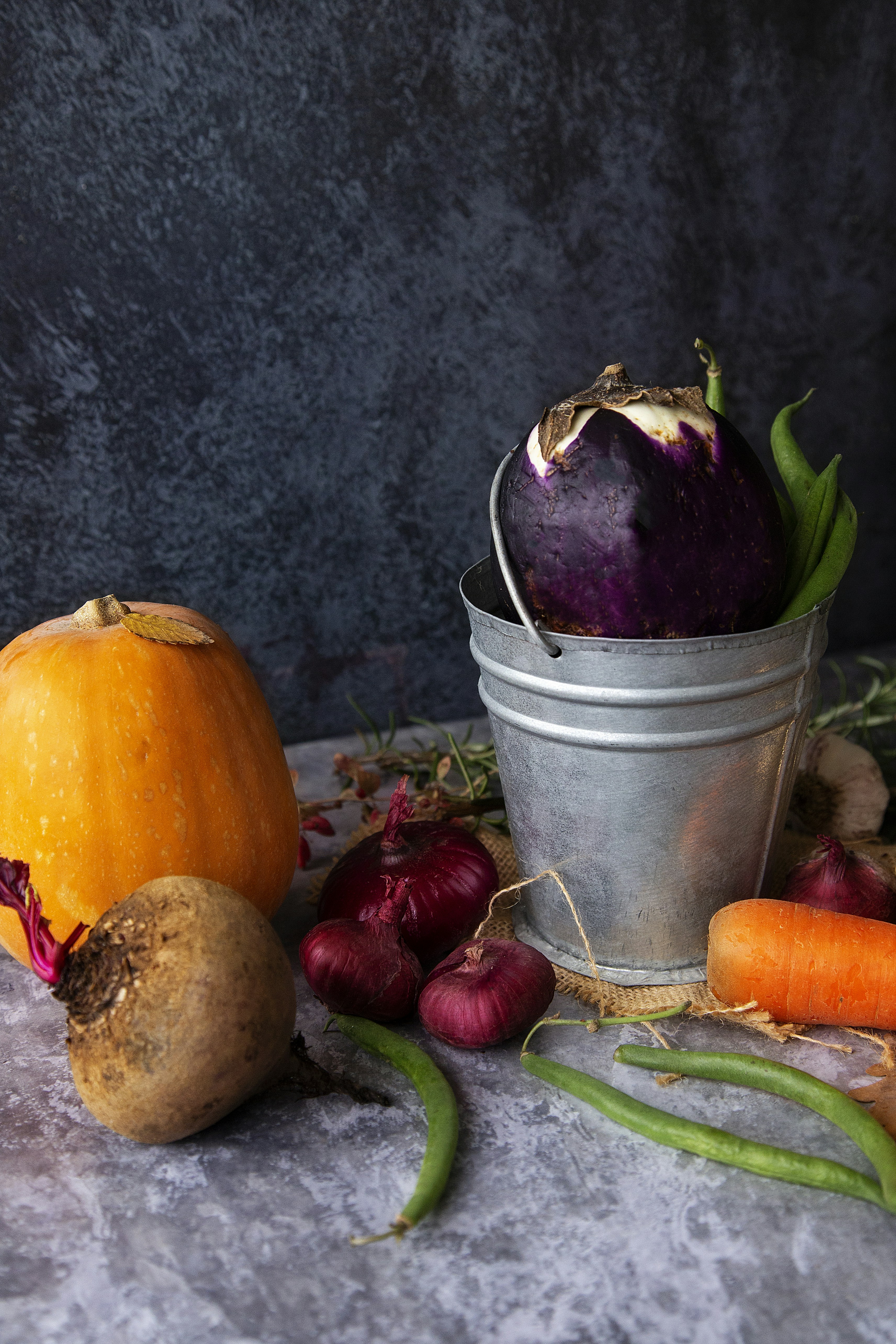 Harvest Palette: Purple Eggplant in a Metal Bucket with Winter Produce