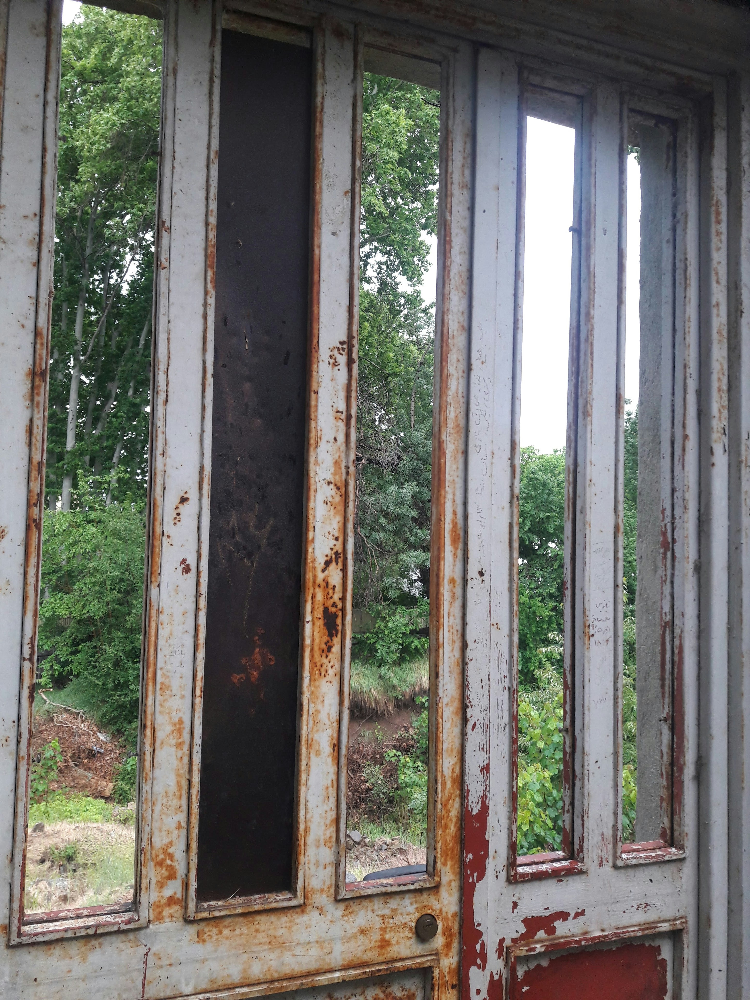Rusted Doorway Framing a Quiet Garden View