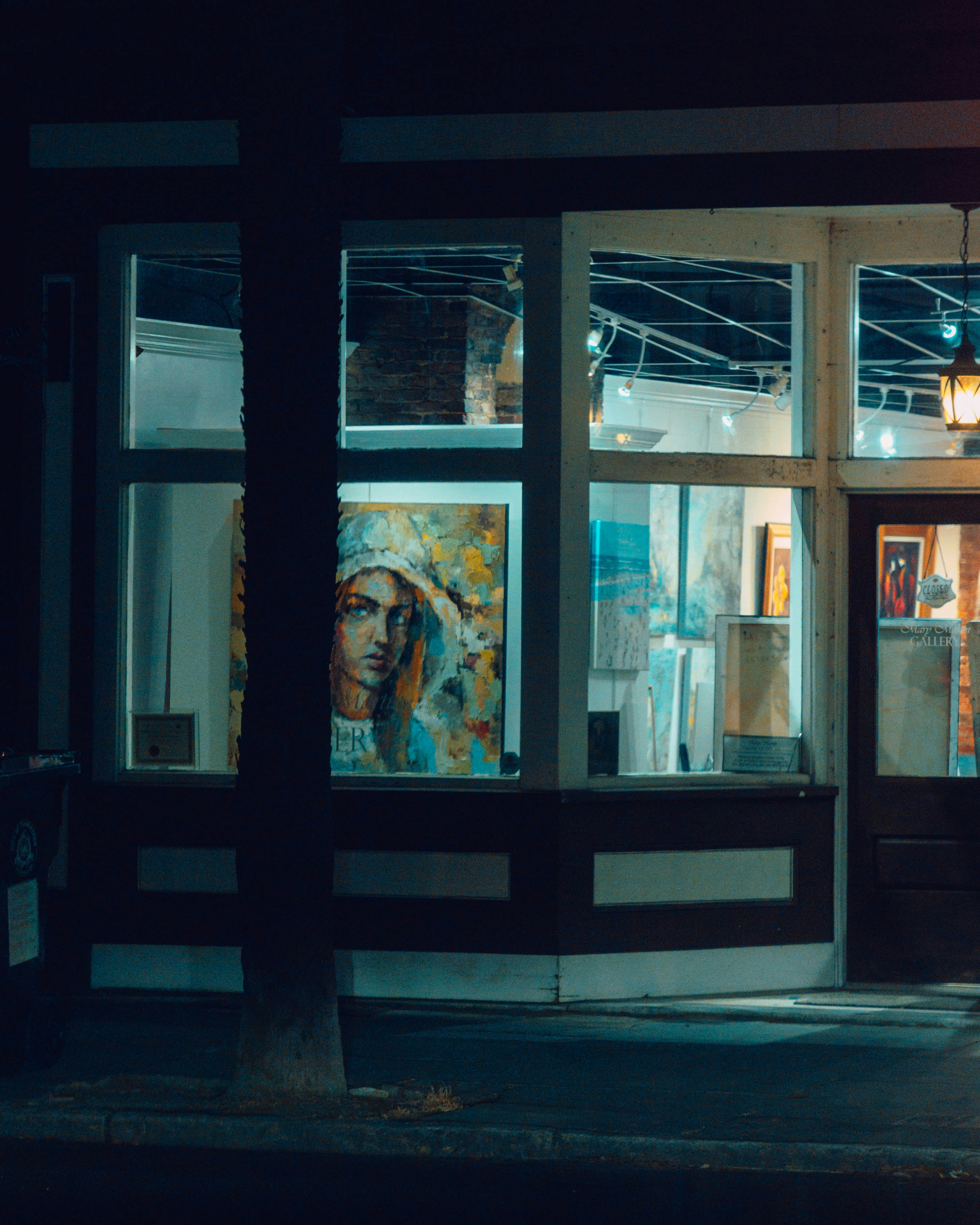 A store front at night with a lit up window photo – Free Painting Image ...