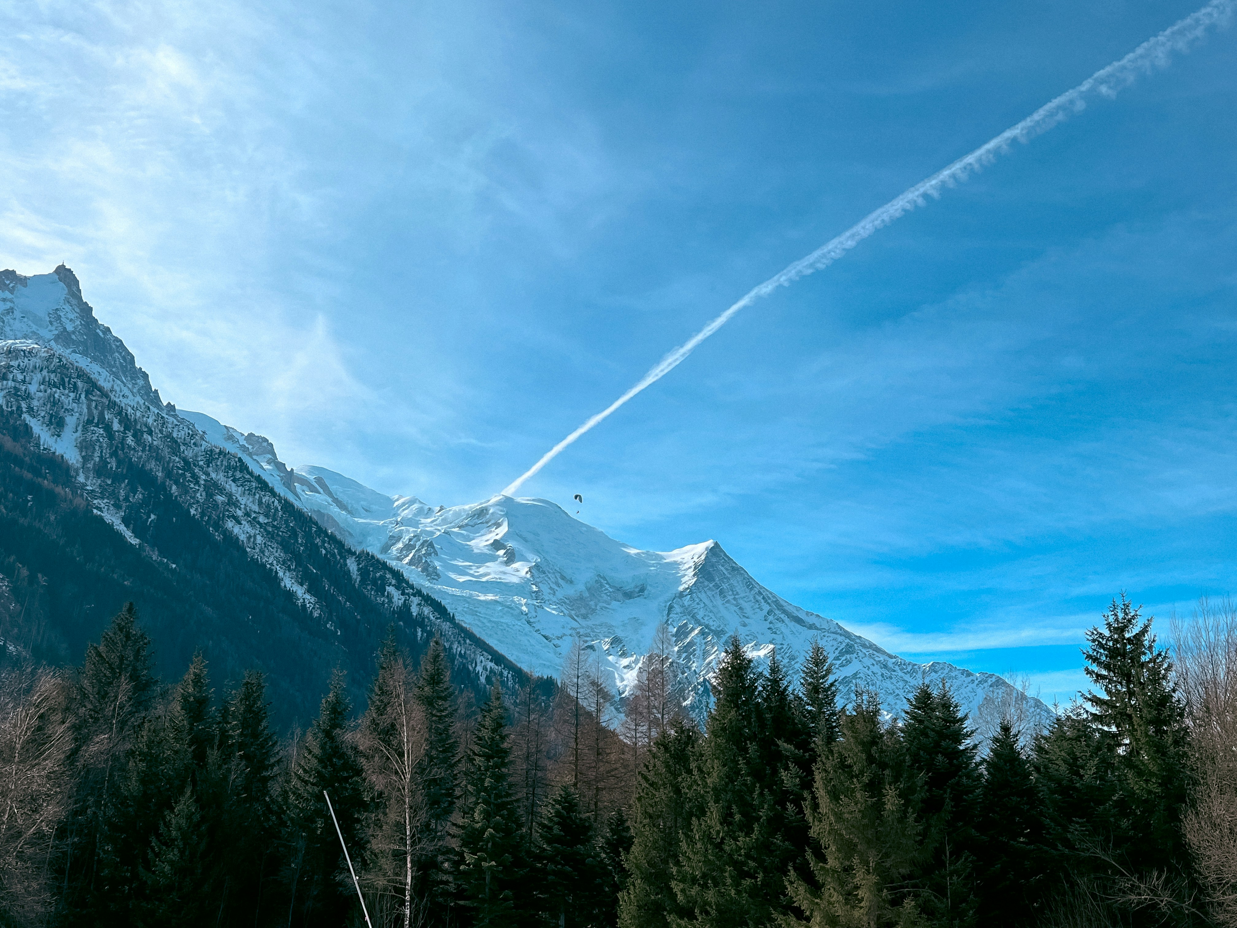 Contrail Across a Snowbound Alpine Crest