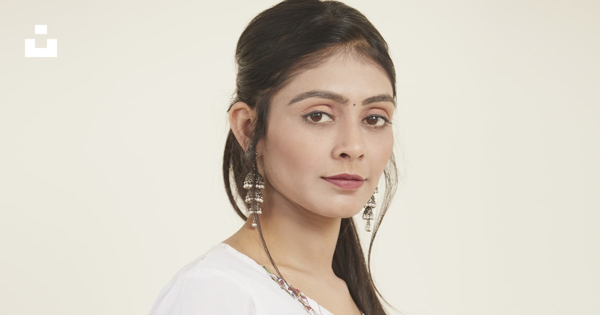 A Woman Wearing A White Dress With A Floral Design Photo Free