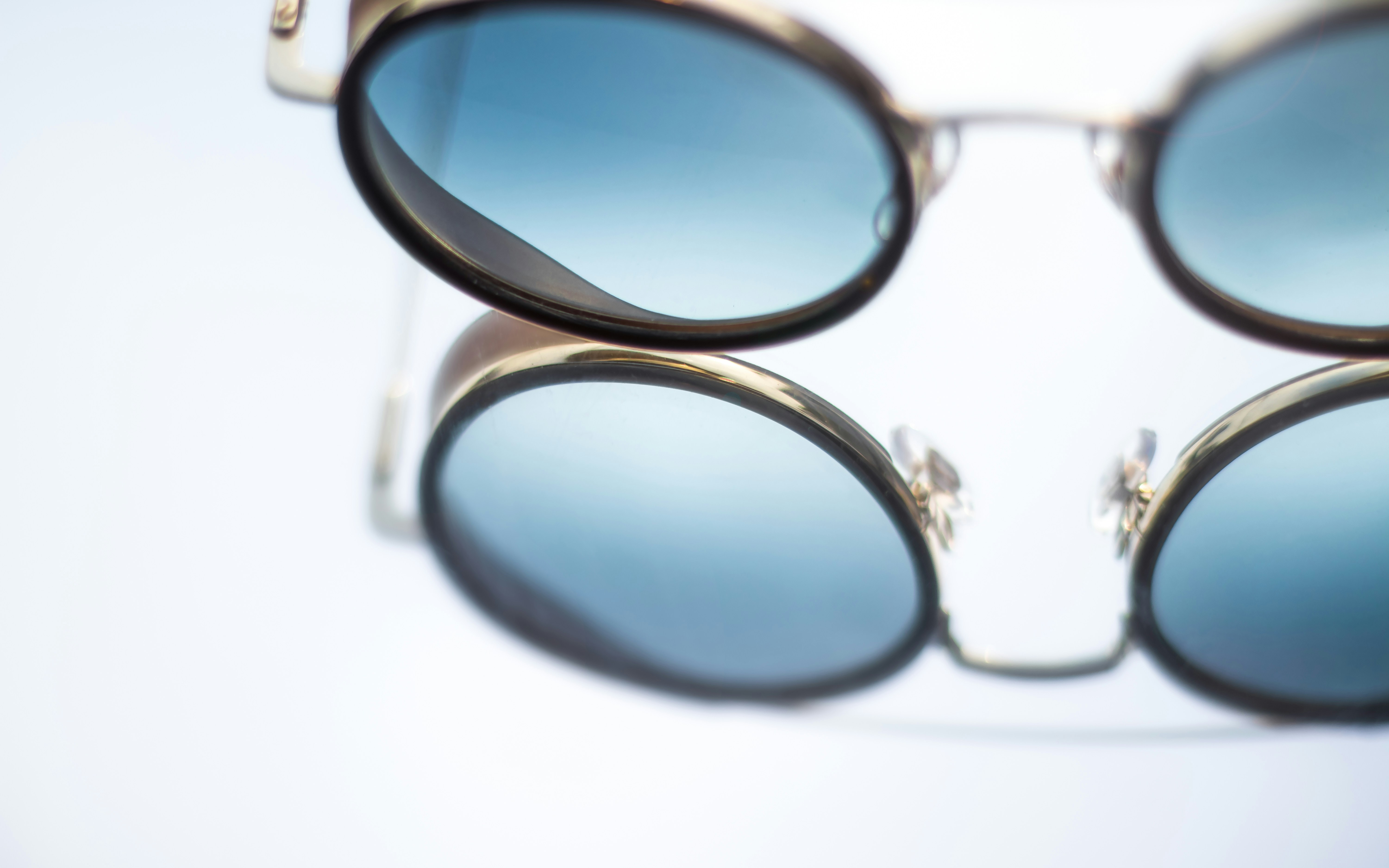 A pair of round sunglasses with blue tinted lenses photo – Free Fashion ...