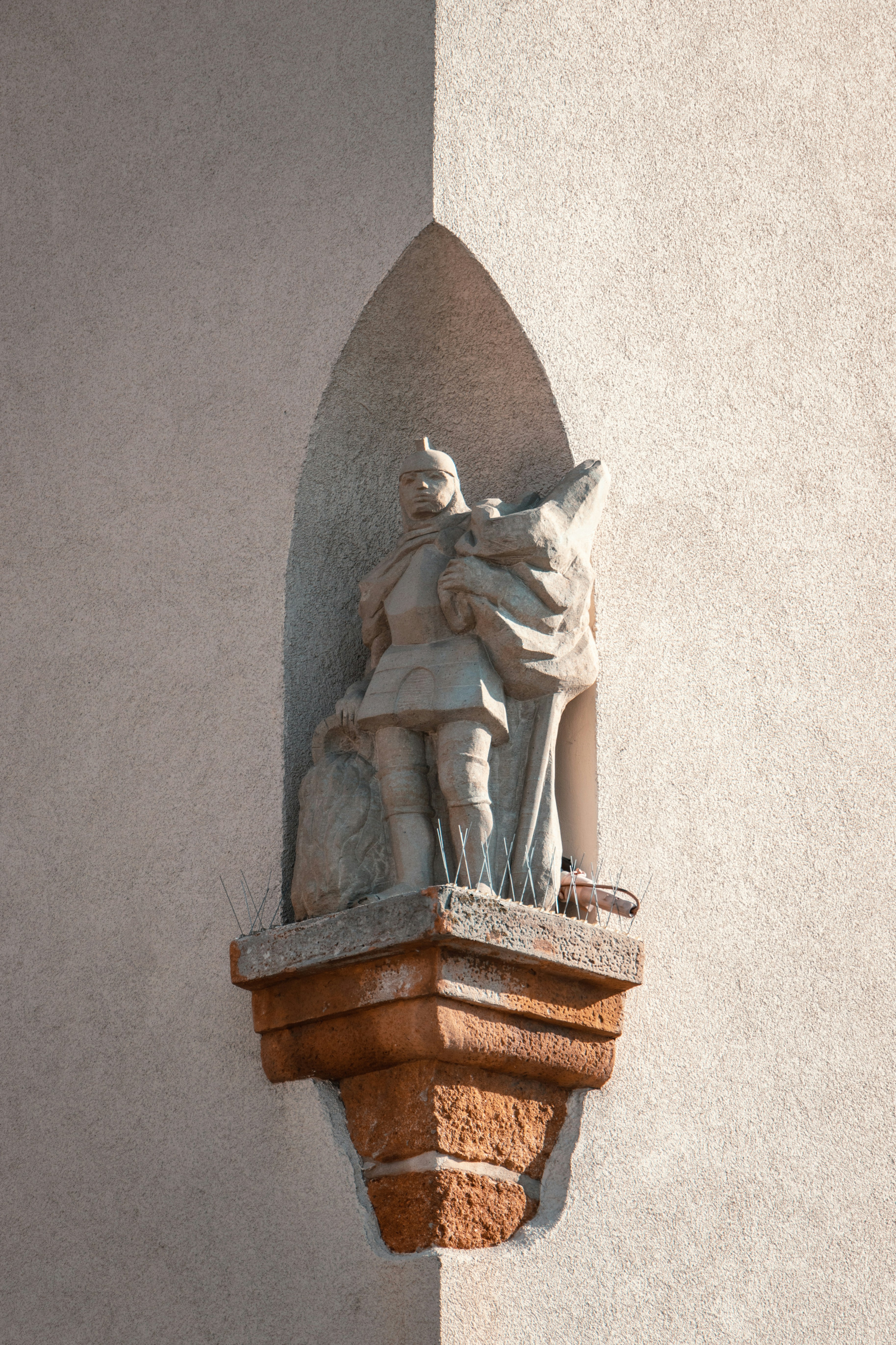 Gnome statue built in the building facade, Olkusz, Poland