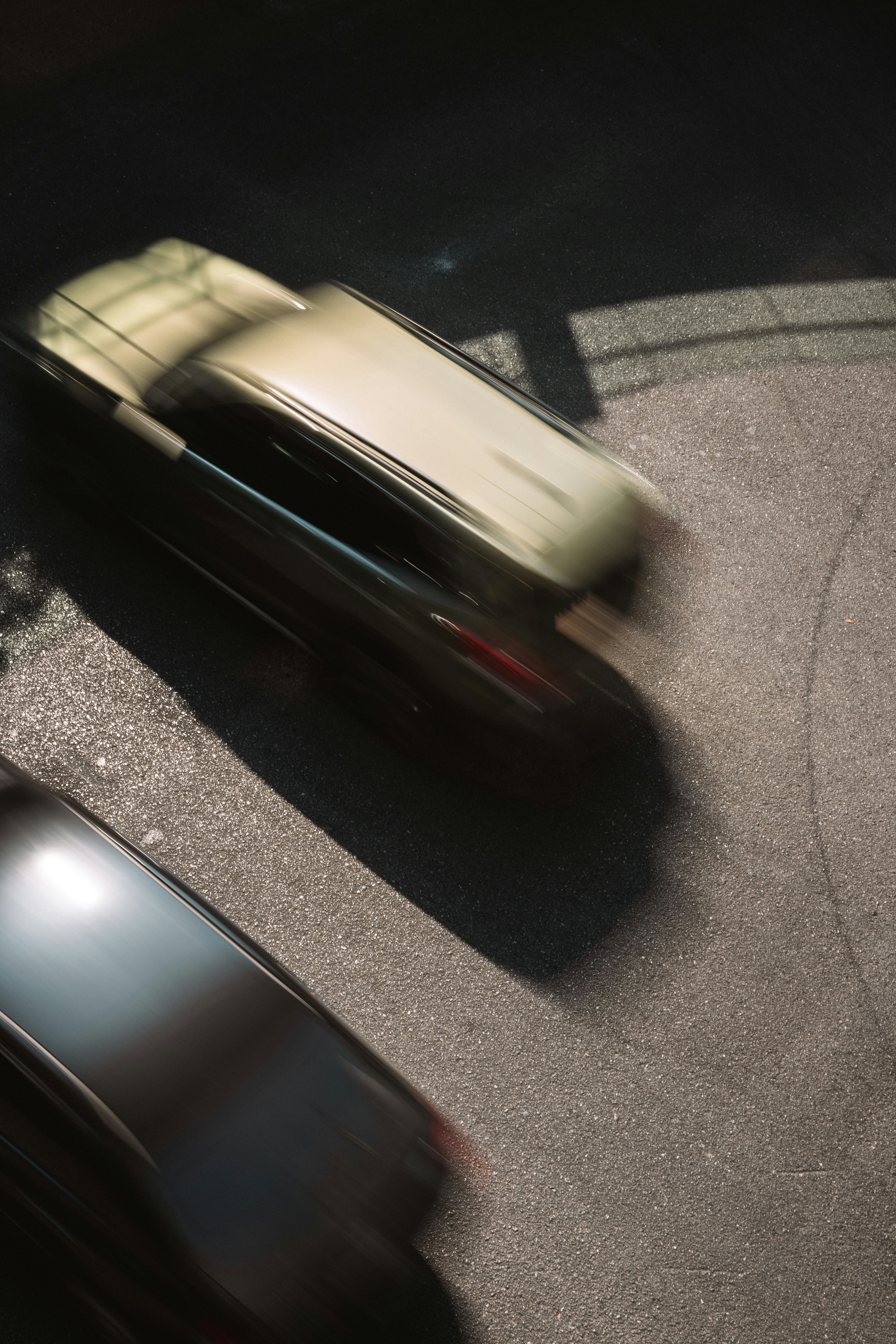 a car driving down a street next to another car