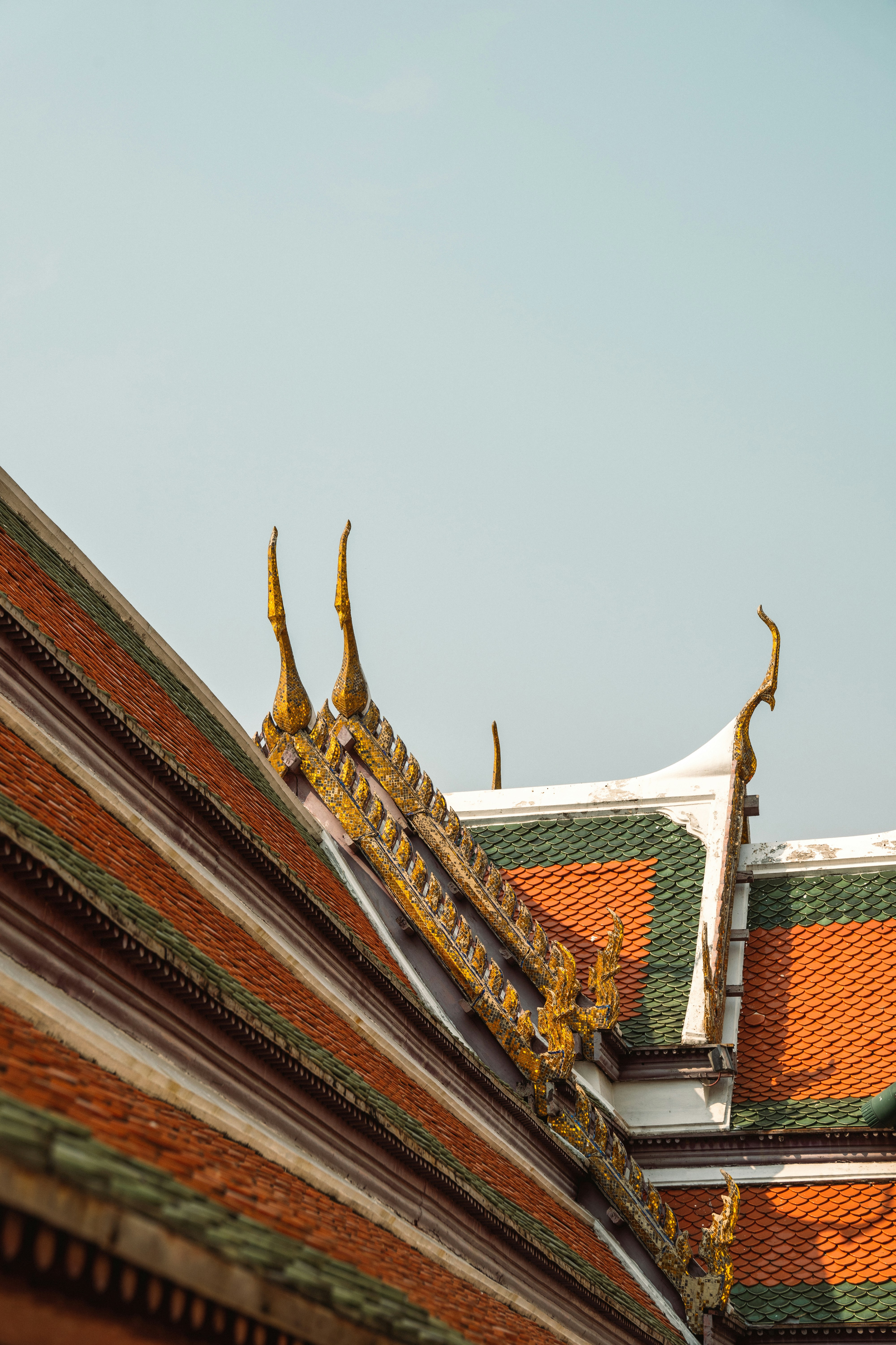 The roof of a building with golden gargoyles on it photo – Free ...