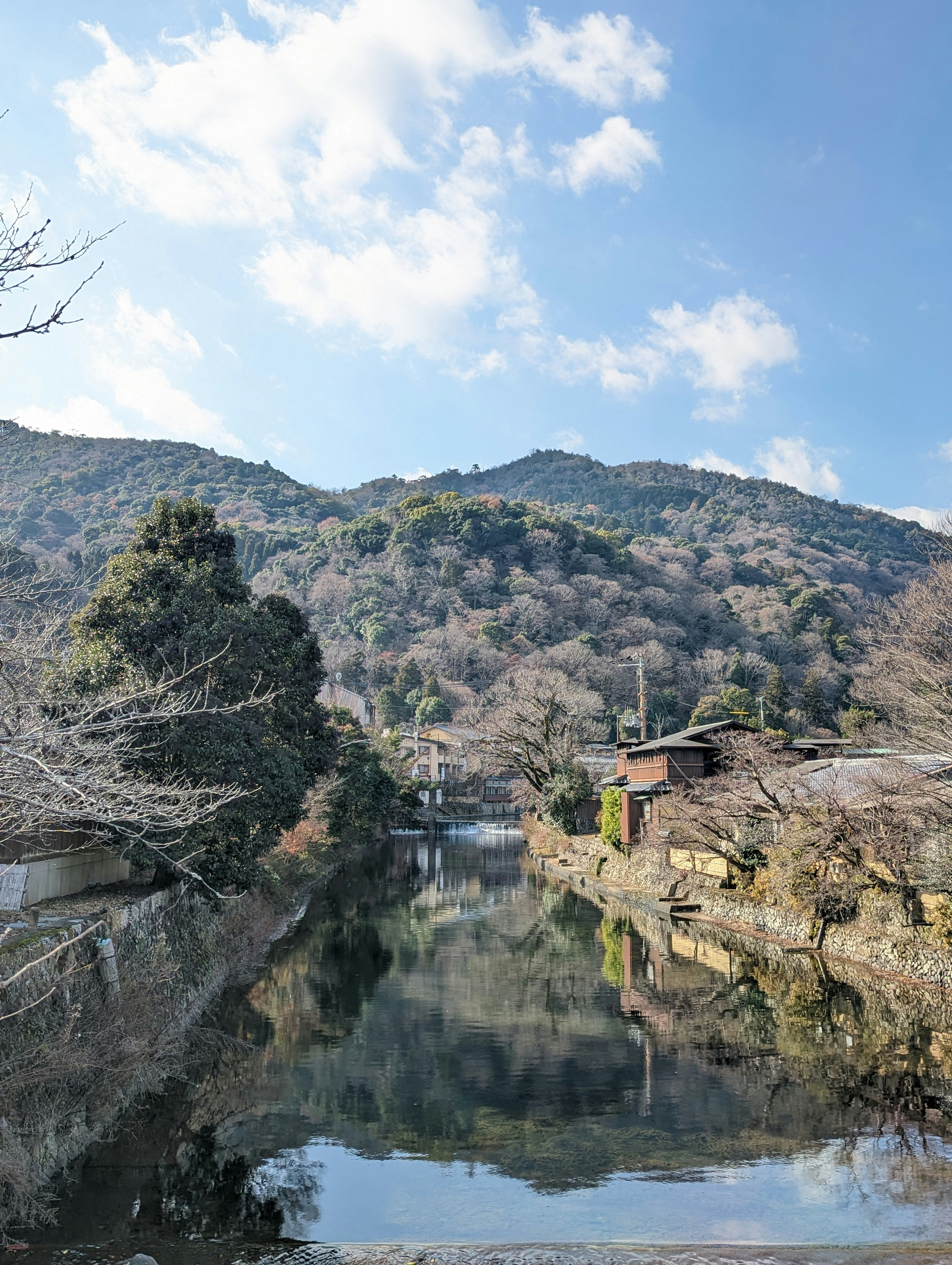 Arashiyama | a river running through a lush green hillside