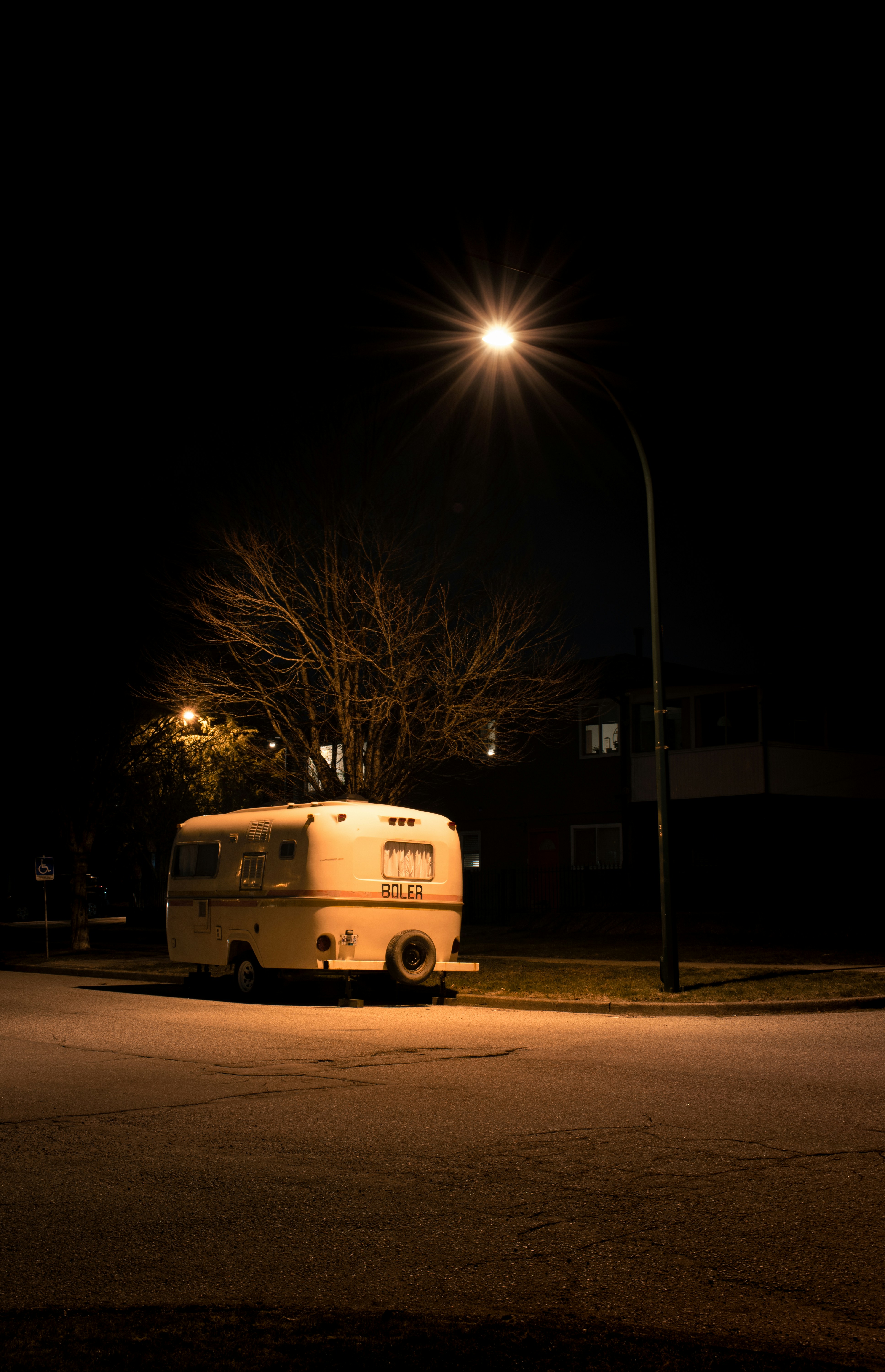 Amber Streetlamp and a Quiet Caravan: Nighttime Still Life