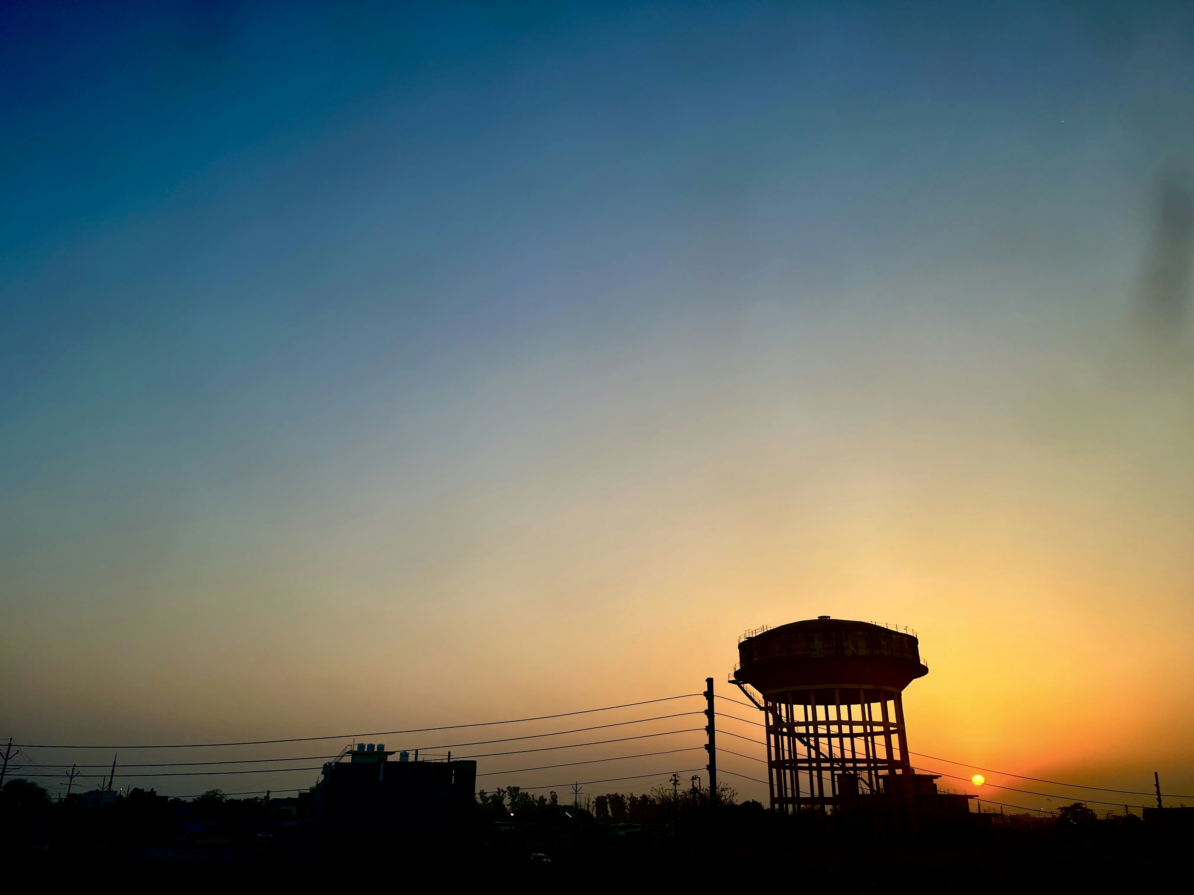 Dusk on the Horizon: Water Tower Silhouette at Sunset
