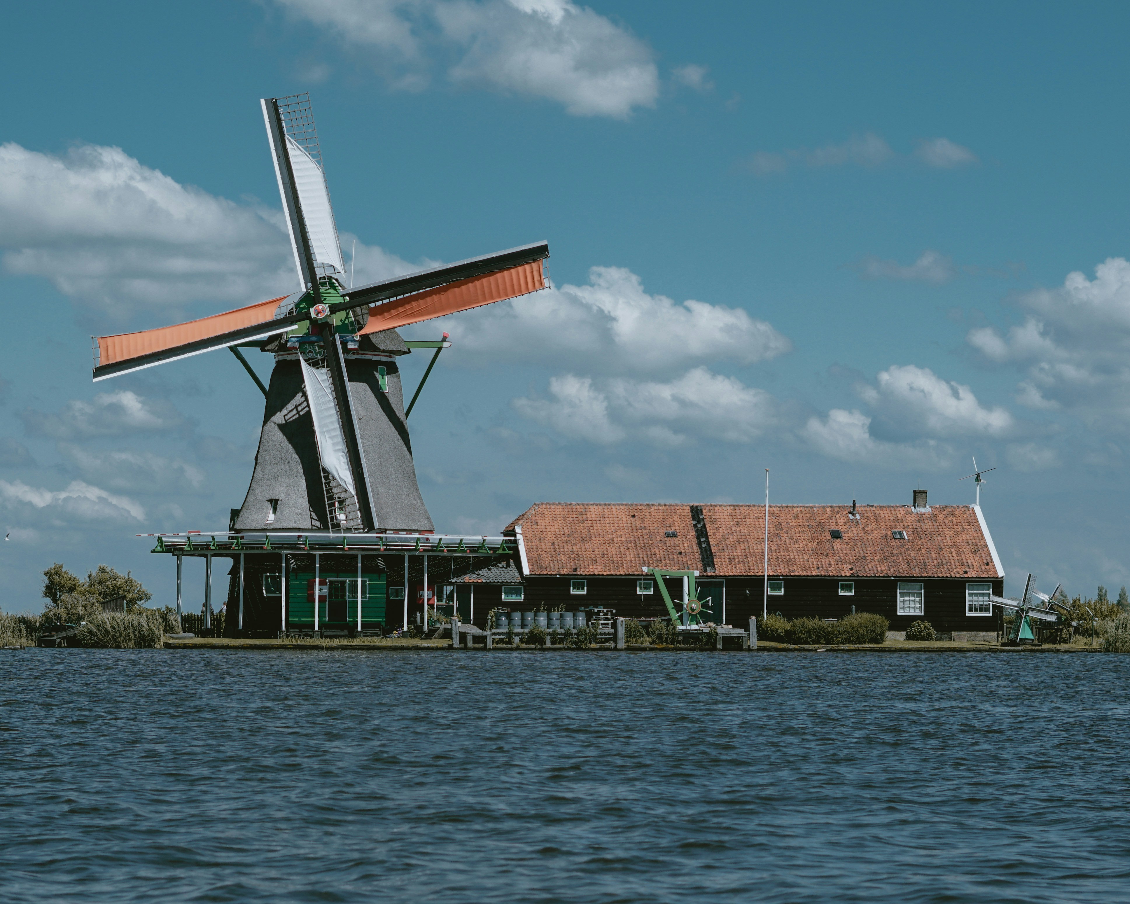A Dutch windmill with sky and lake background in Zaanse Schans, Netherlands