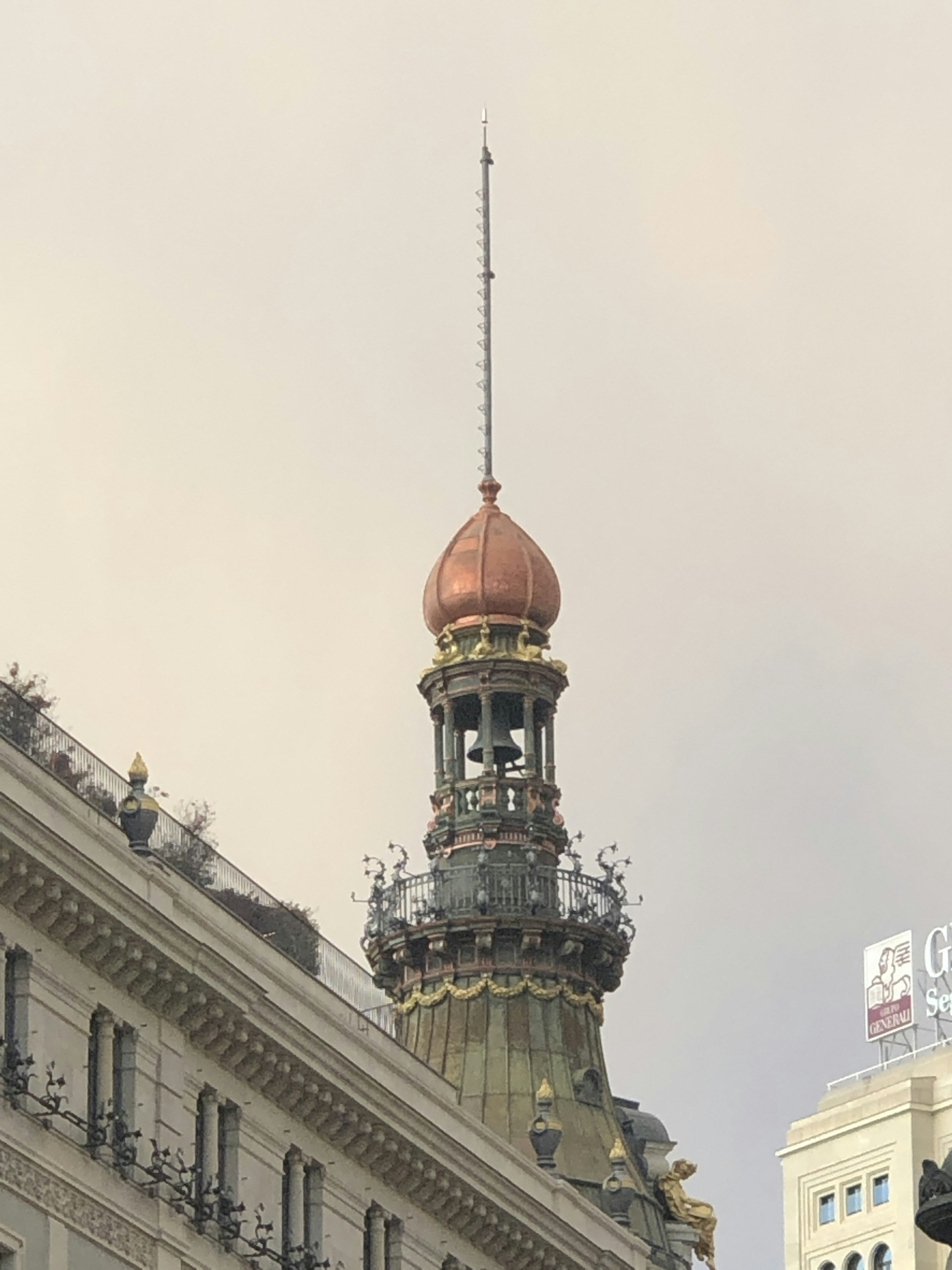Copper-Domed Spire Rising Over a Classical Facade
