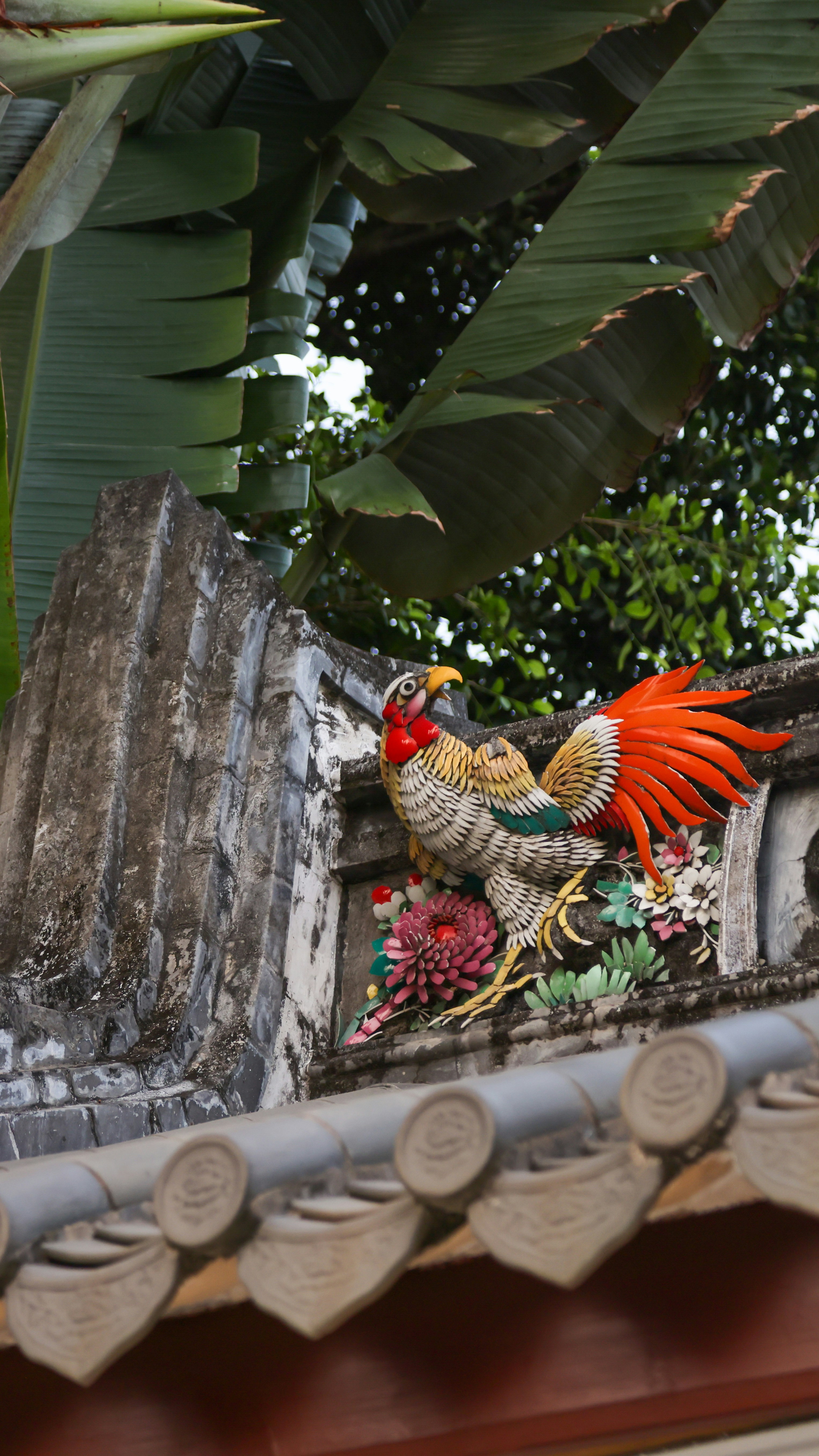 Crimson Phoenix Relief: A Vivid Ceramic Ode on Weathered Stone