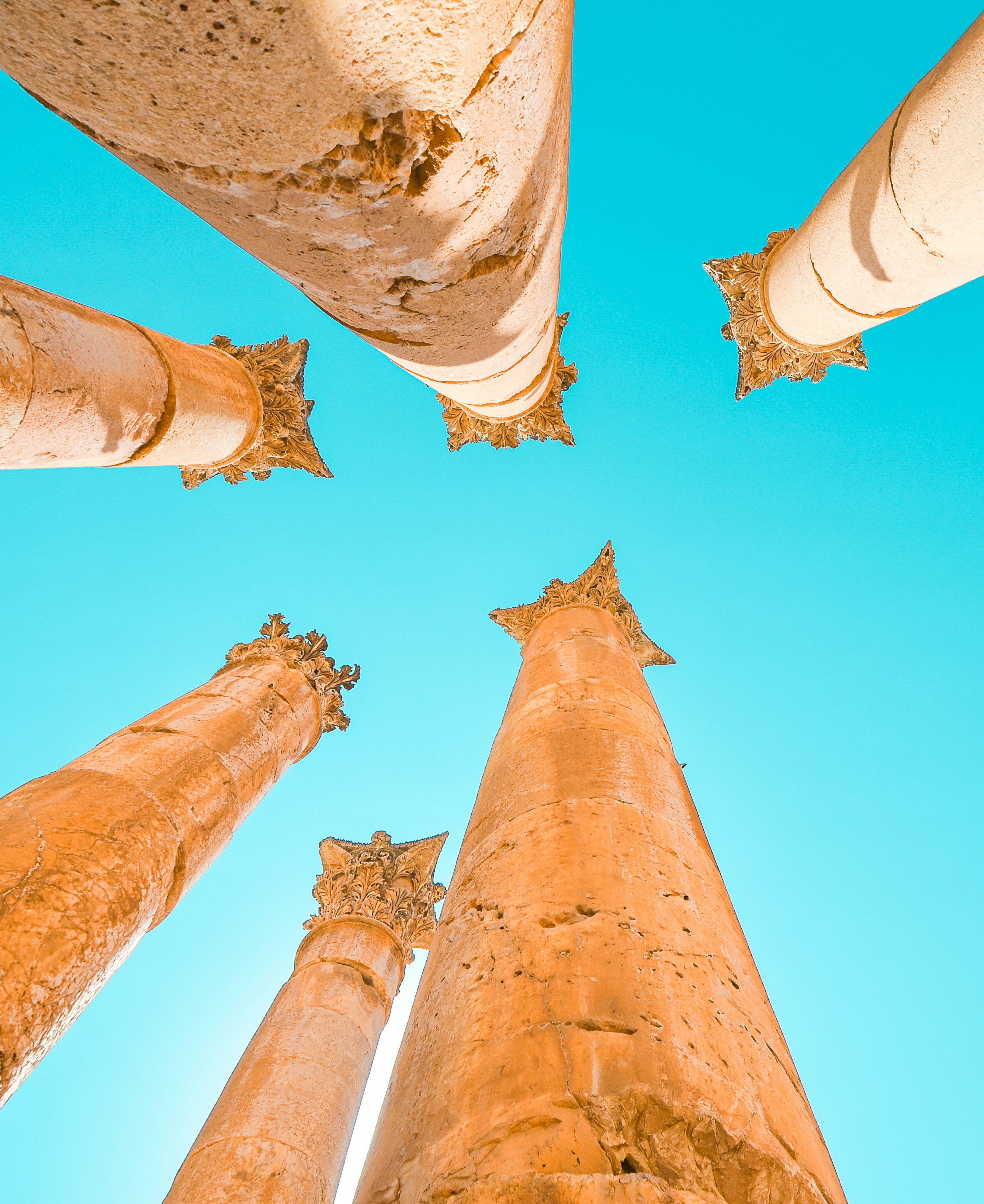 Skyward Sentinels: Carved Columns Rising into Cerulean Sky