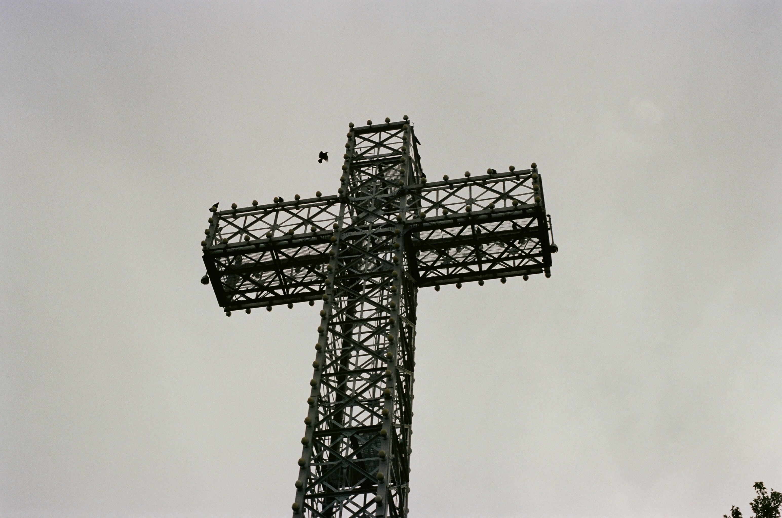 A large metal cross on top of a metal structure photo – Free Religious ...