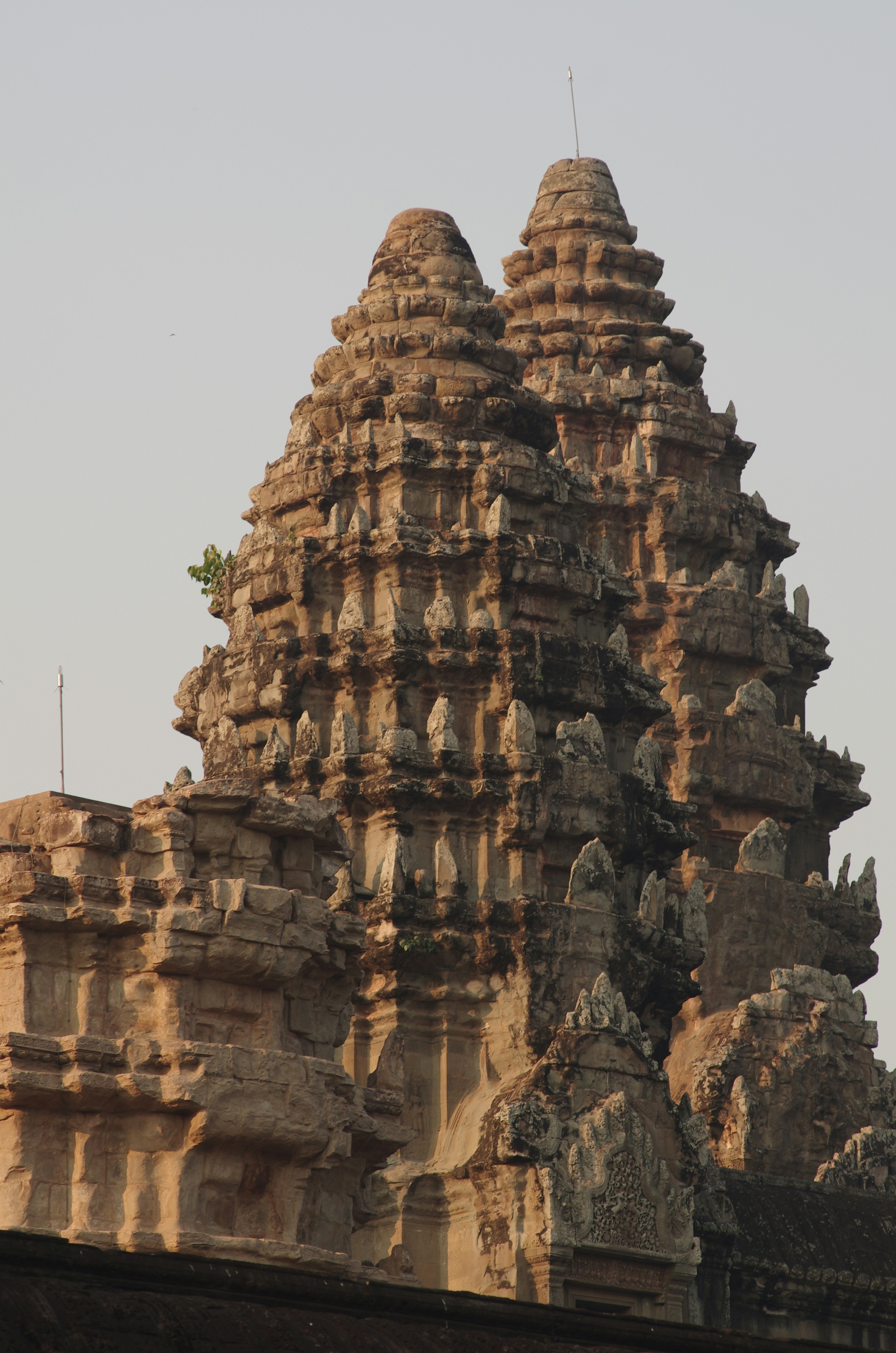 A very tall tower with a clock on it's side photo – Free Angkor wat ...