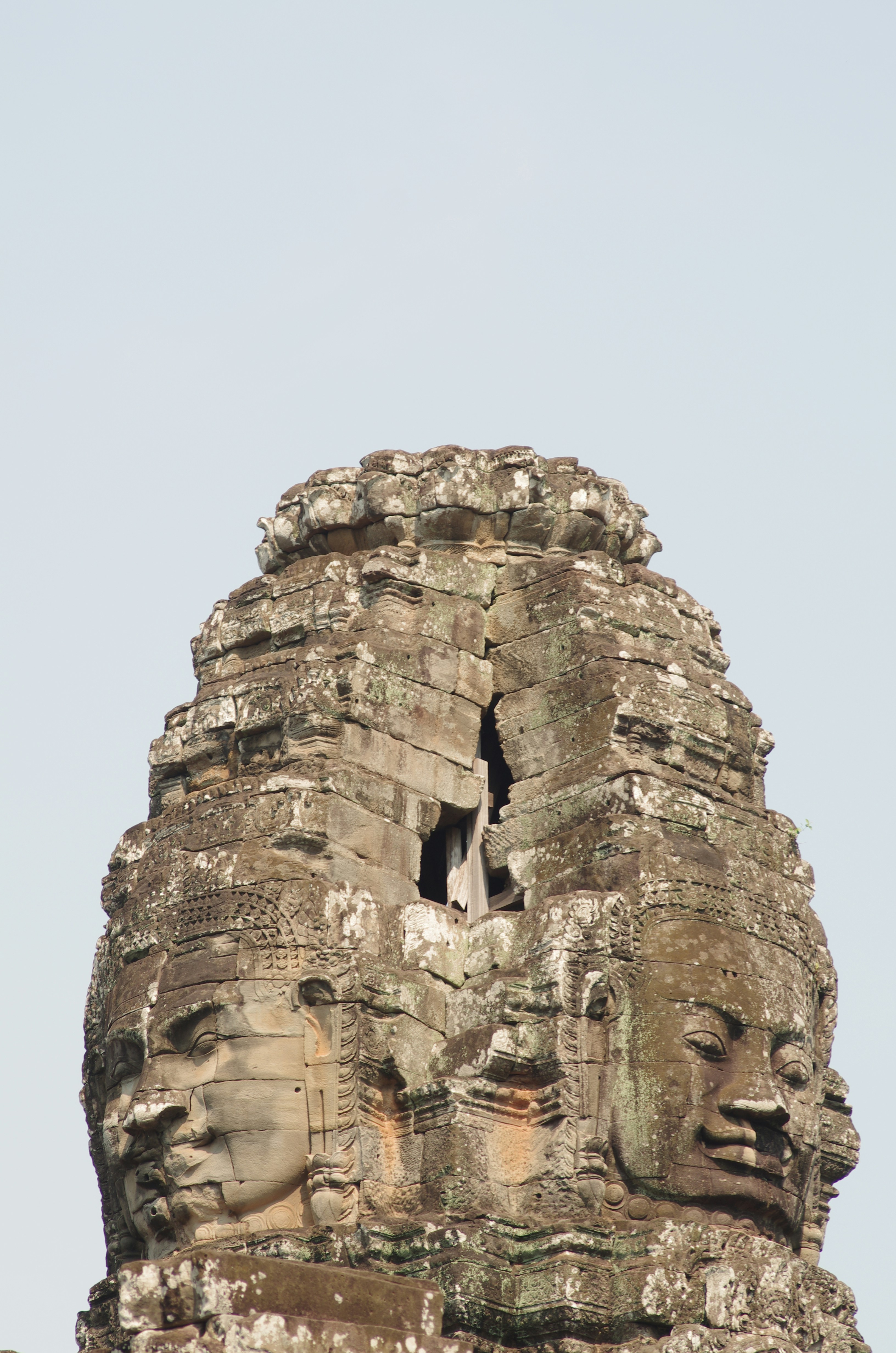 Whispered Faces Crown a Weathered Bayon Tower