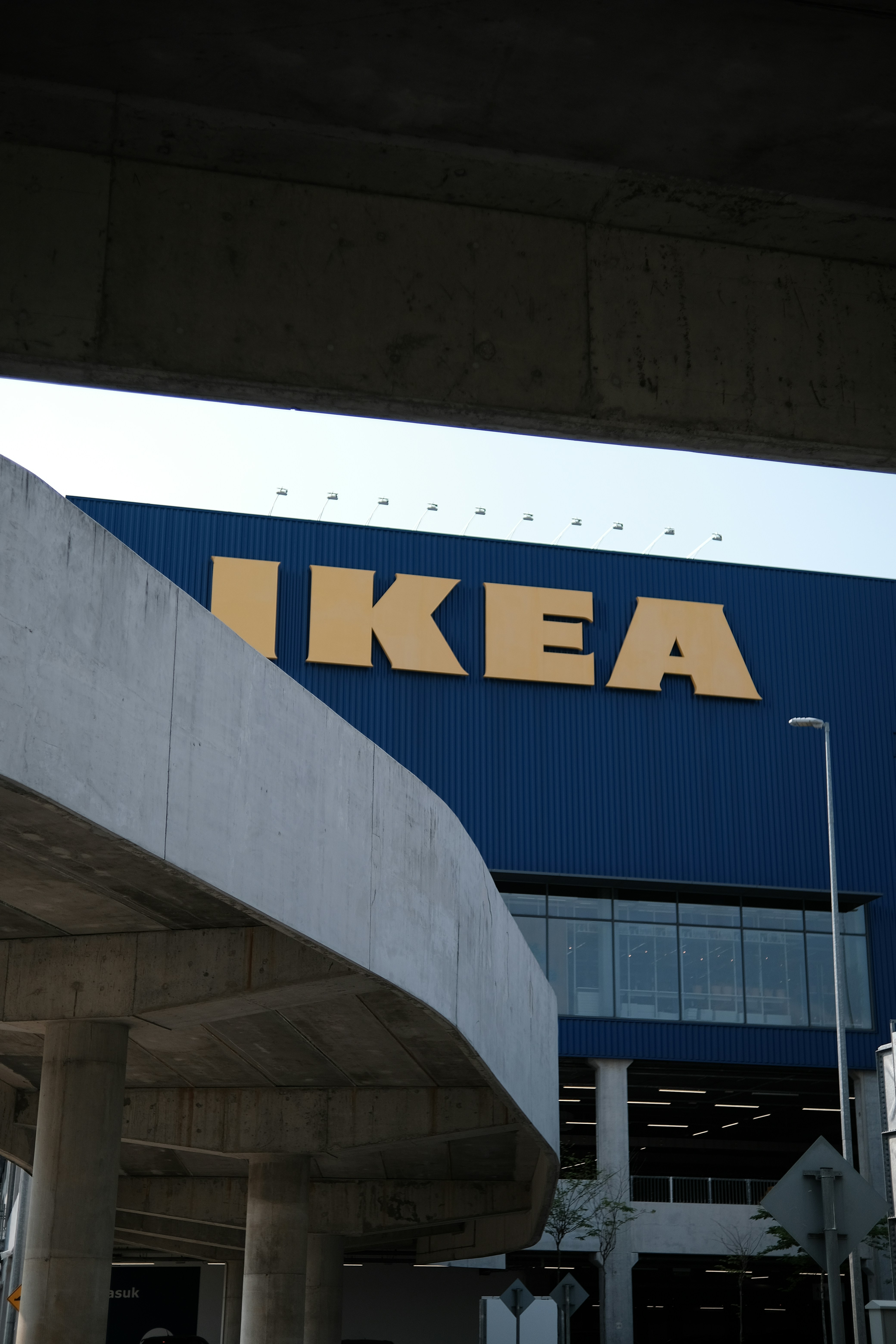 Blue Facade, Gold Letters: IKEA Under the Concrete Arc