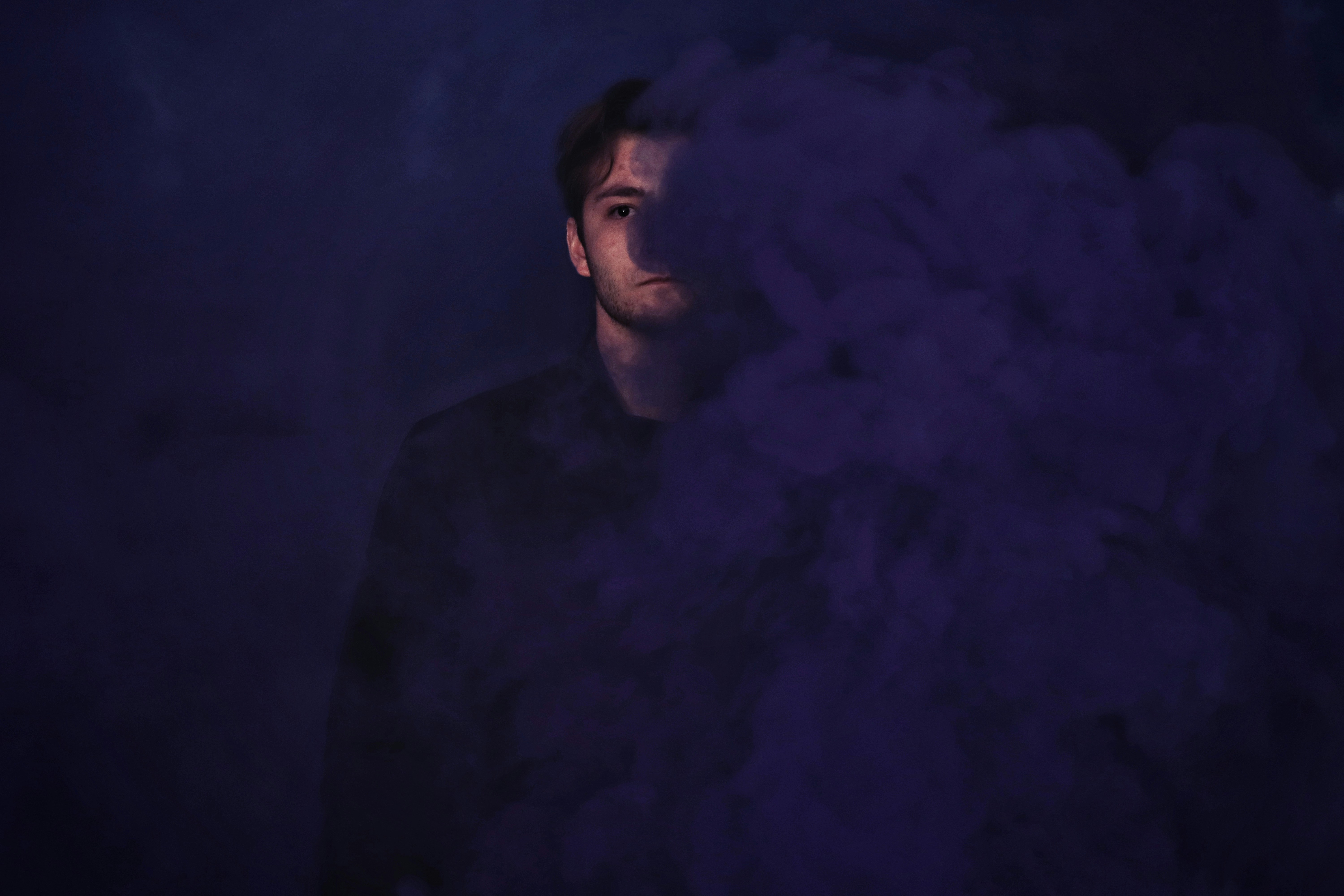 A man standing in a smoke filled room photo – Free Image on Unsplash