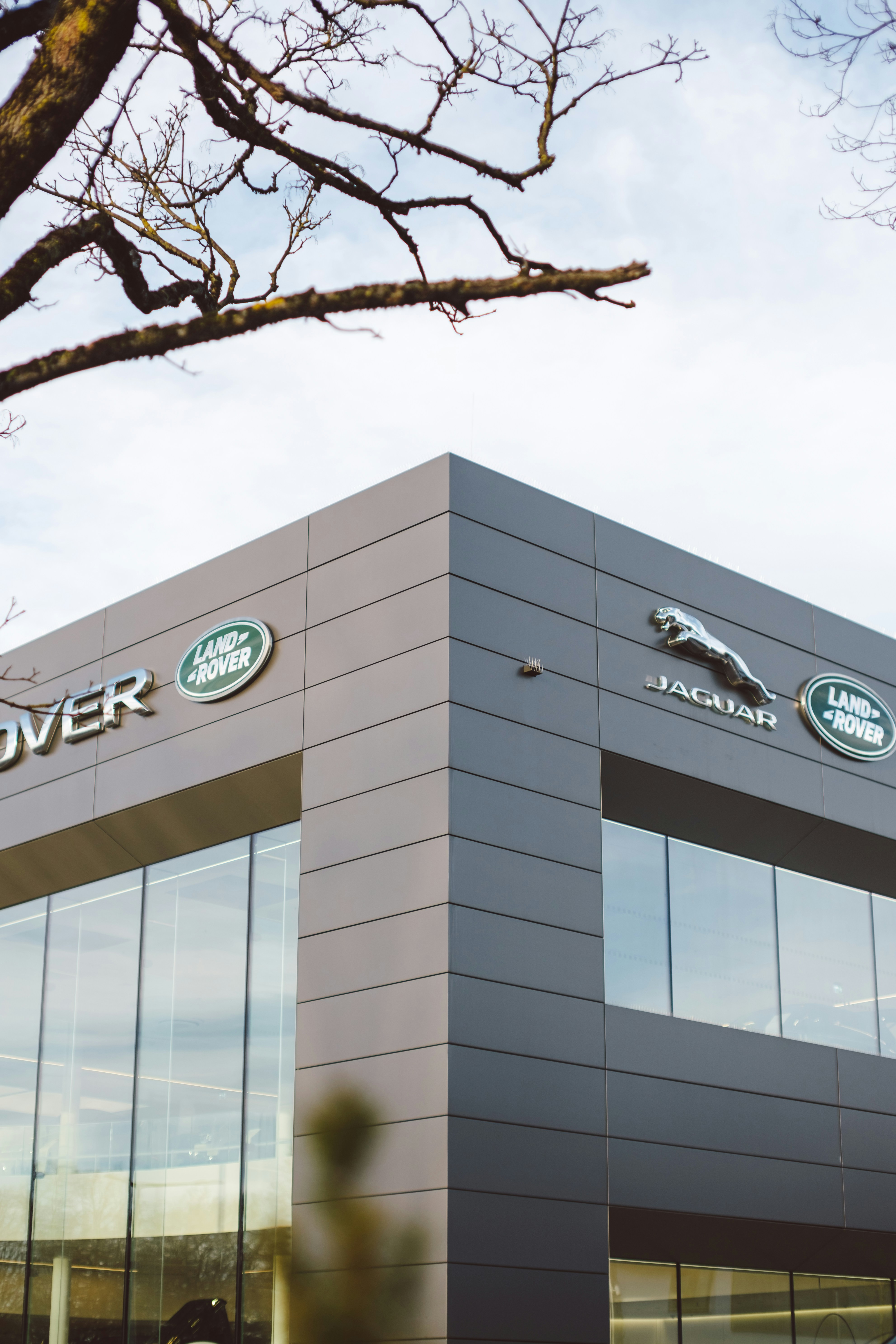 Jaguar-Land Rover Showroom: a bold angular corner against a pale sky