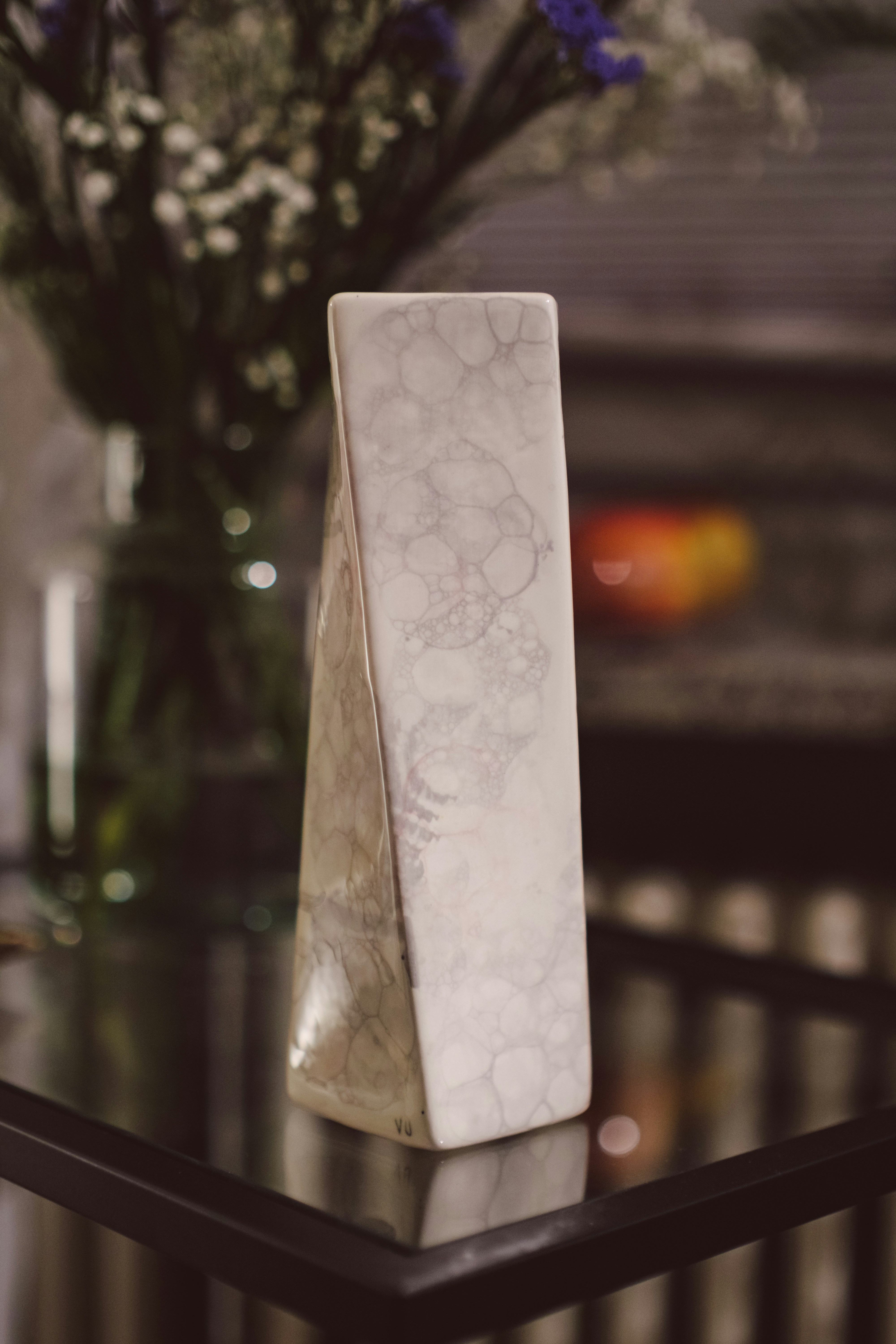 Marble Monolith: A Marble-Textured Sculpture Anchoring a Dim Kitchen Scene