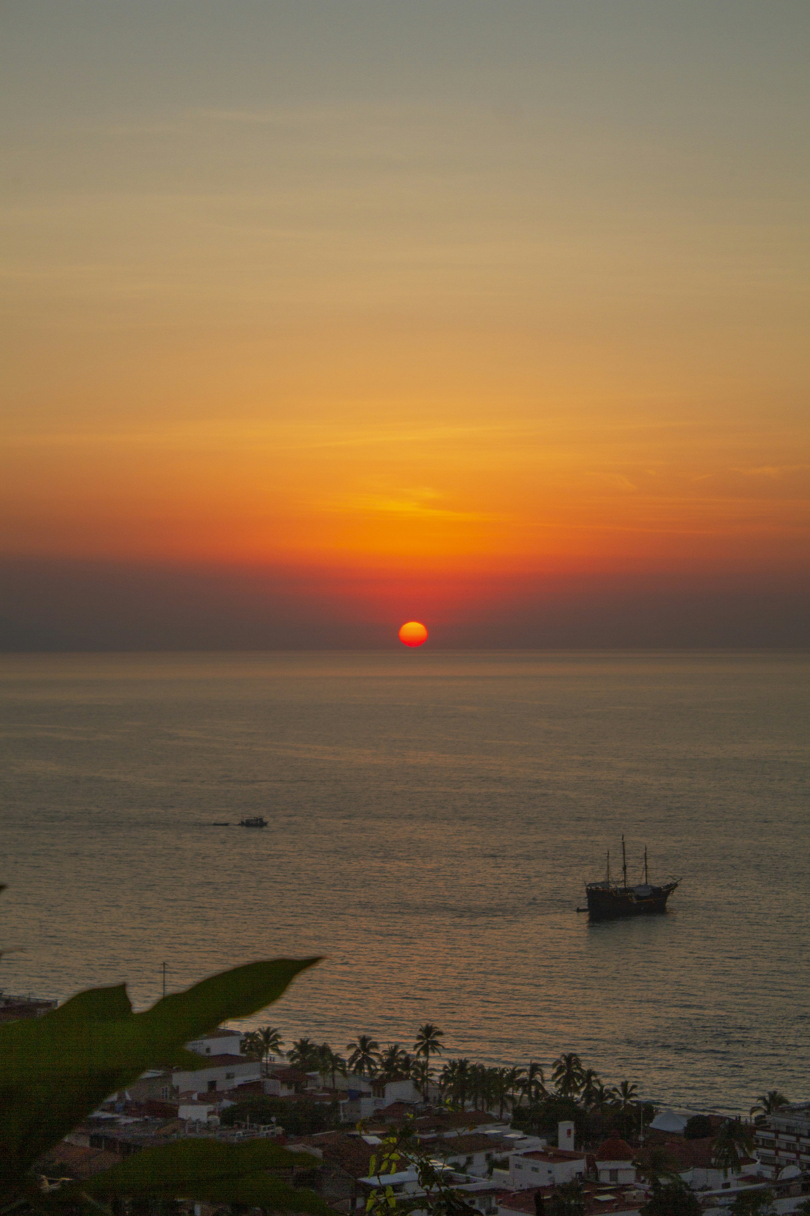 Sunset Overture over a Quiet Bay with a Distant Boat