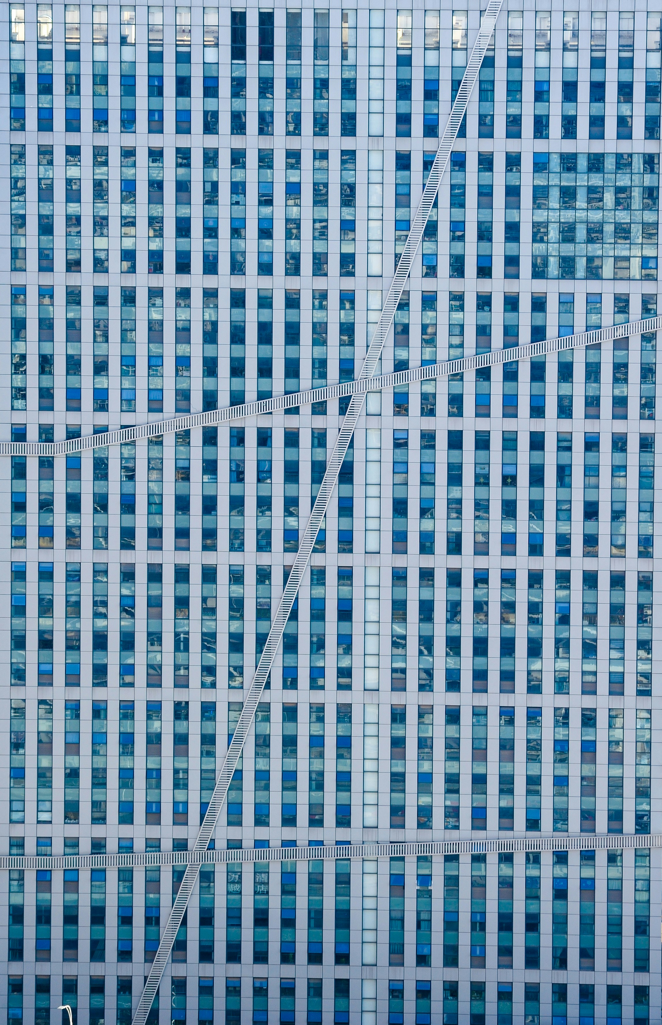 Crisscrossed Cable Lines Over a Blue Glass Grid
