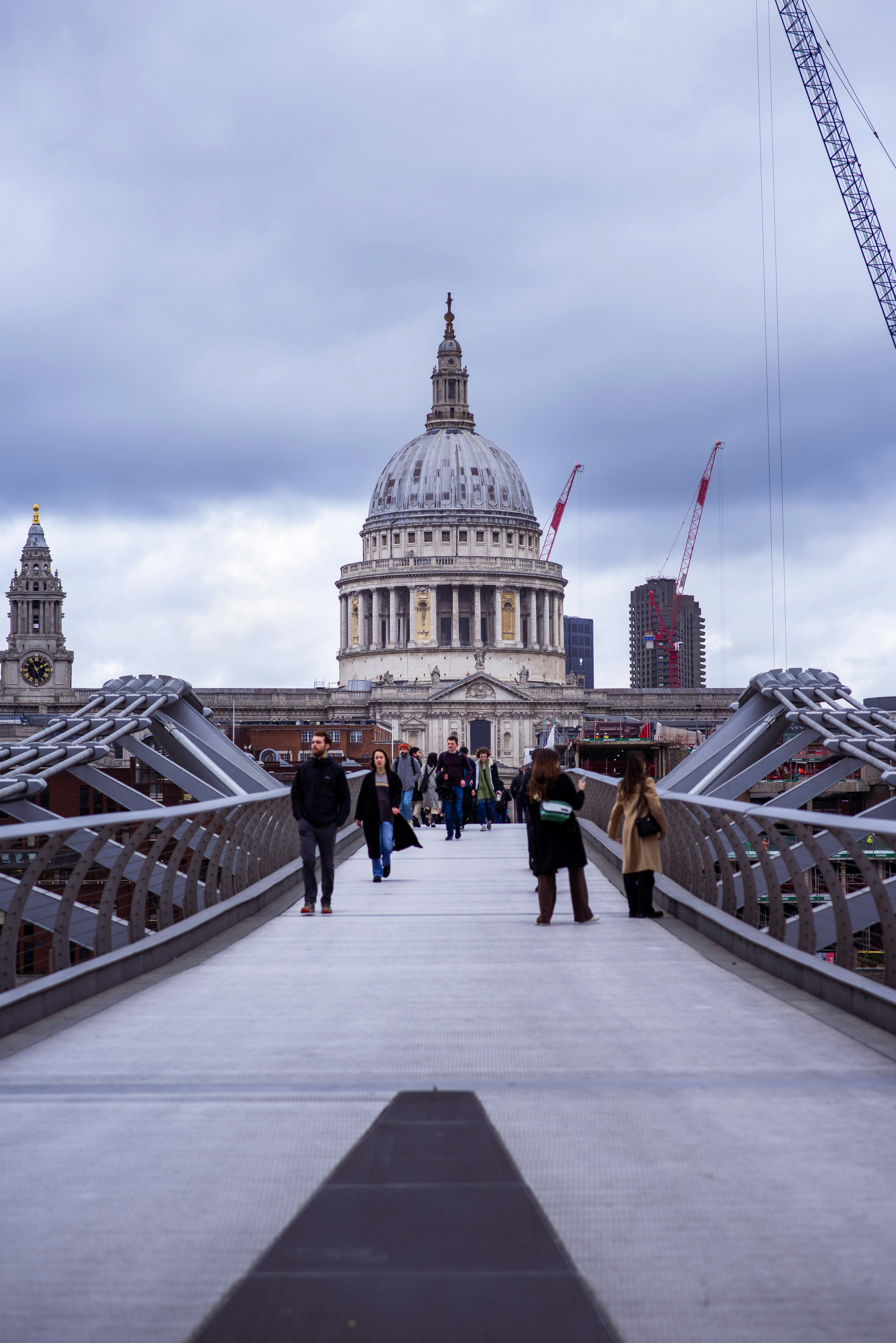 A group of people walking across a bridge photo – Free London Image on ...