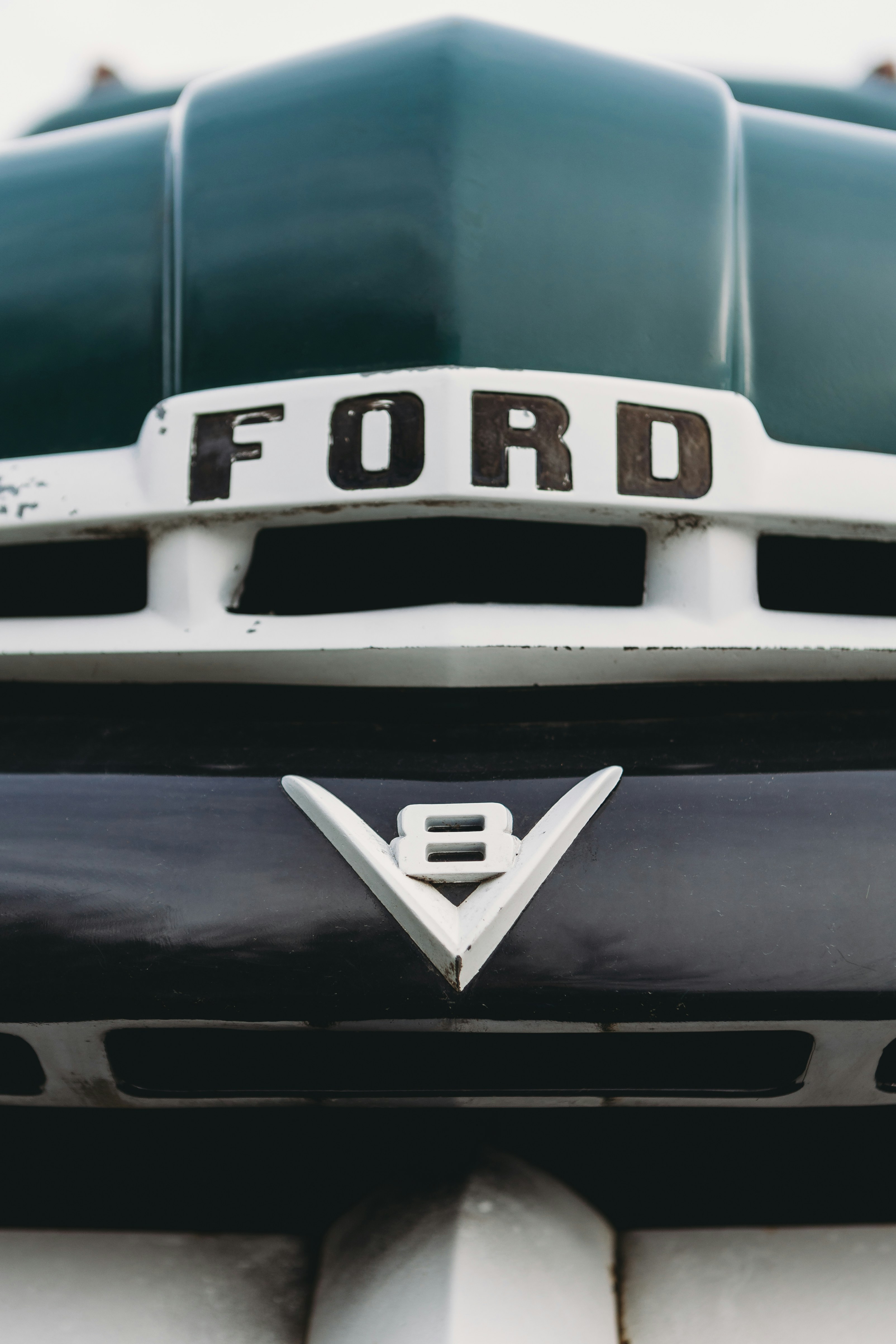 Close-Up of a Weathered Ford Emblem: Vintage Grille Portrait