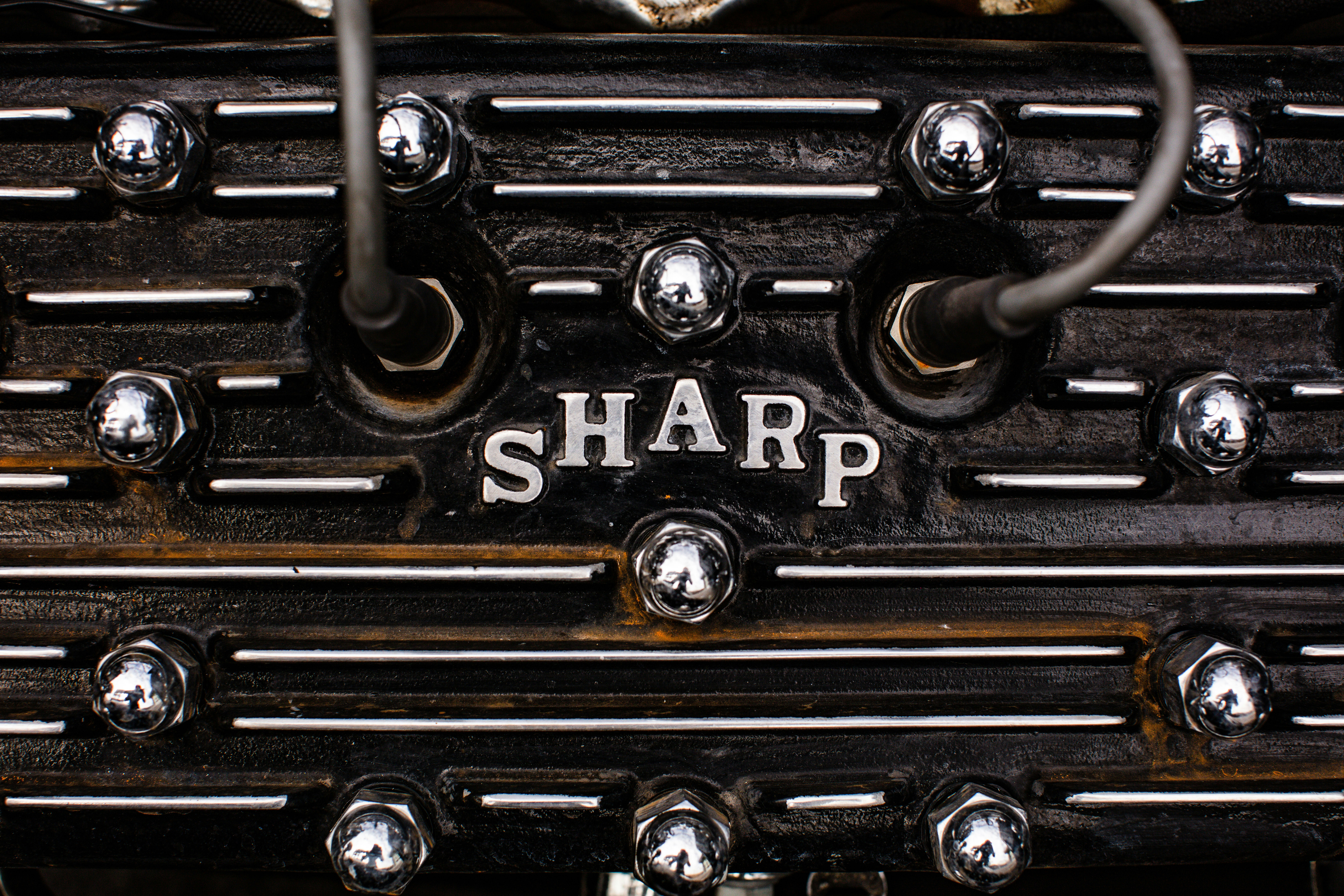 A close up of a metal object with the word sharp on it photo – Free ...
