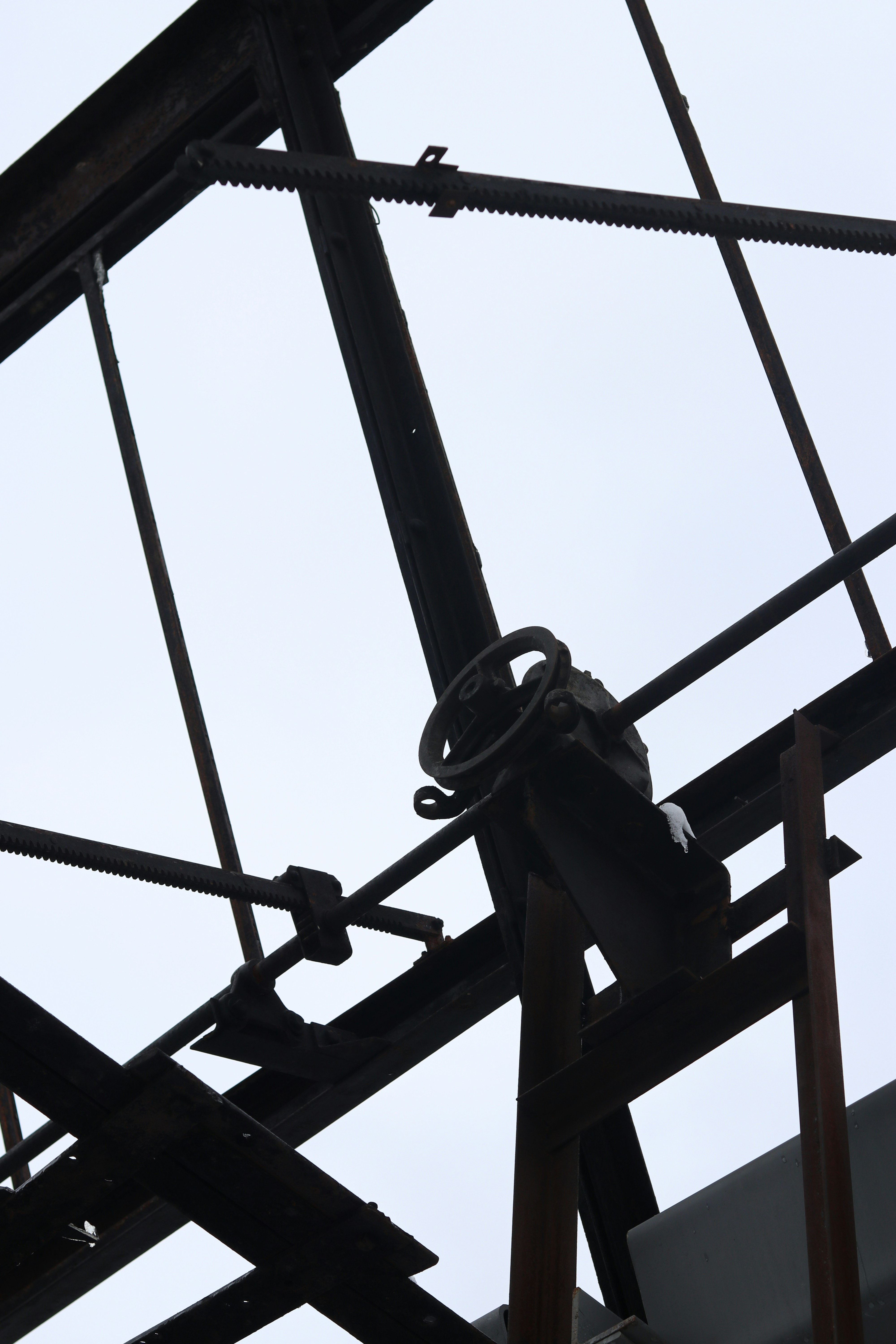 a close up of a metal structure with a sky background