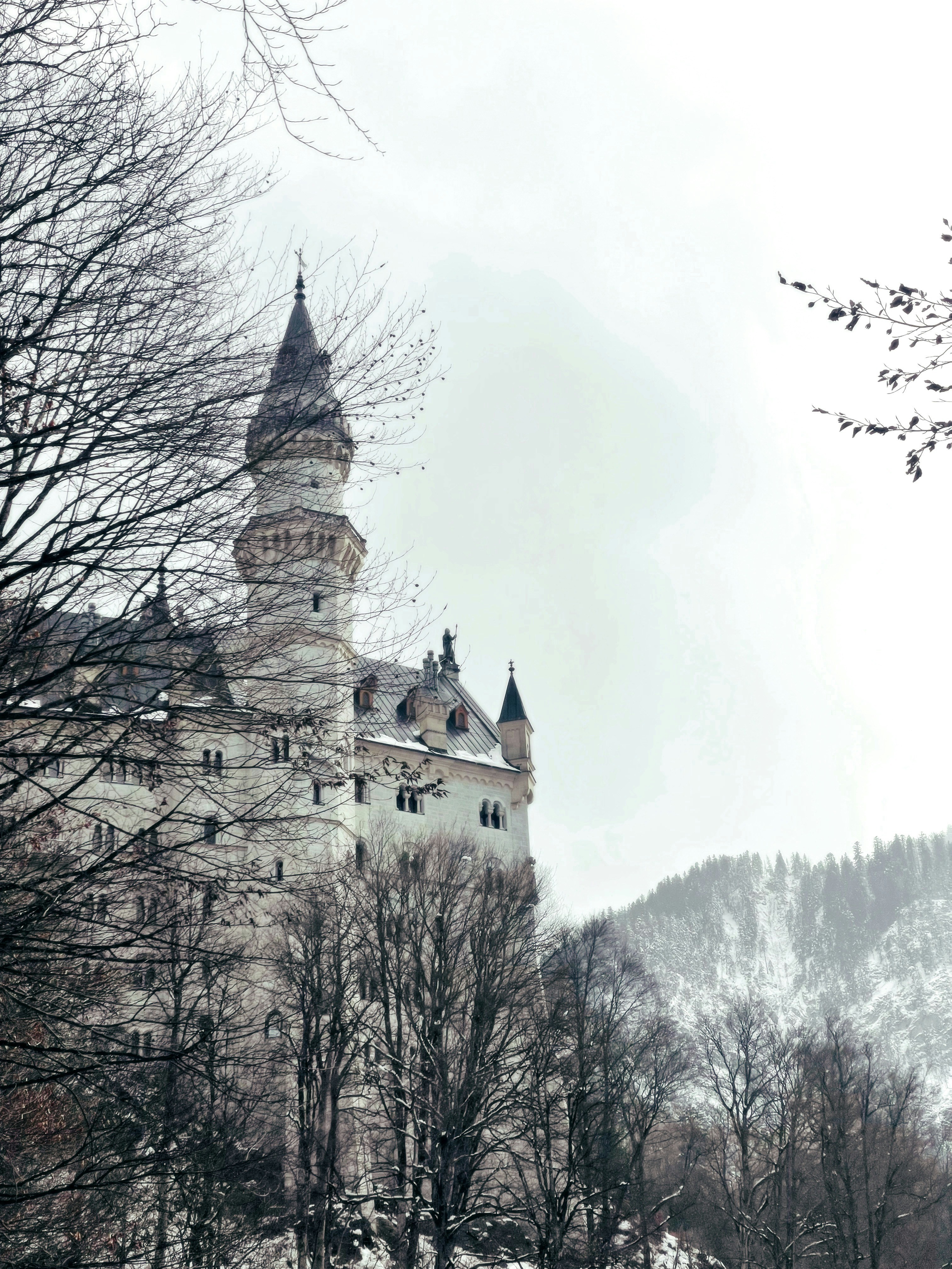 A castle with a clock on the top of it photo – Free Neuschwanstein ...